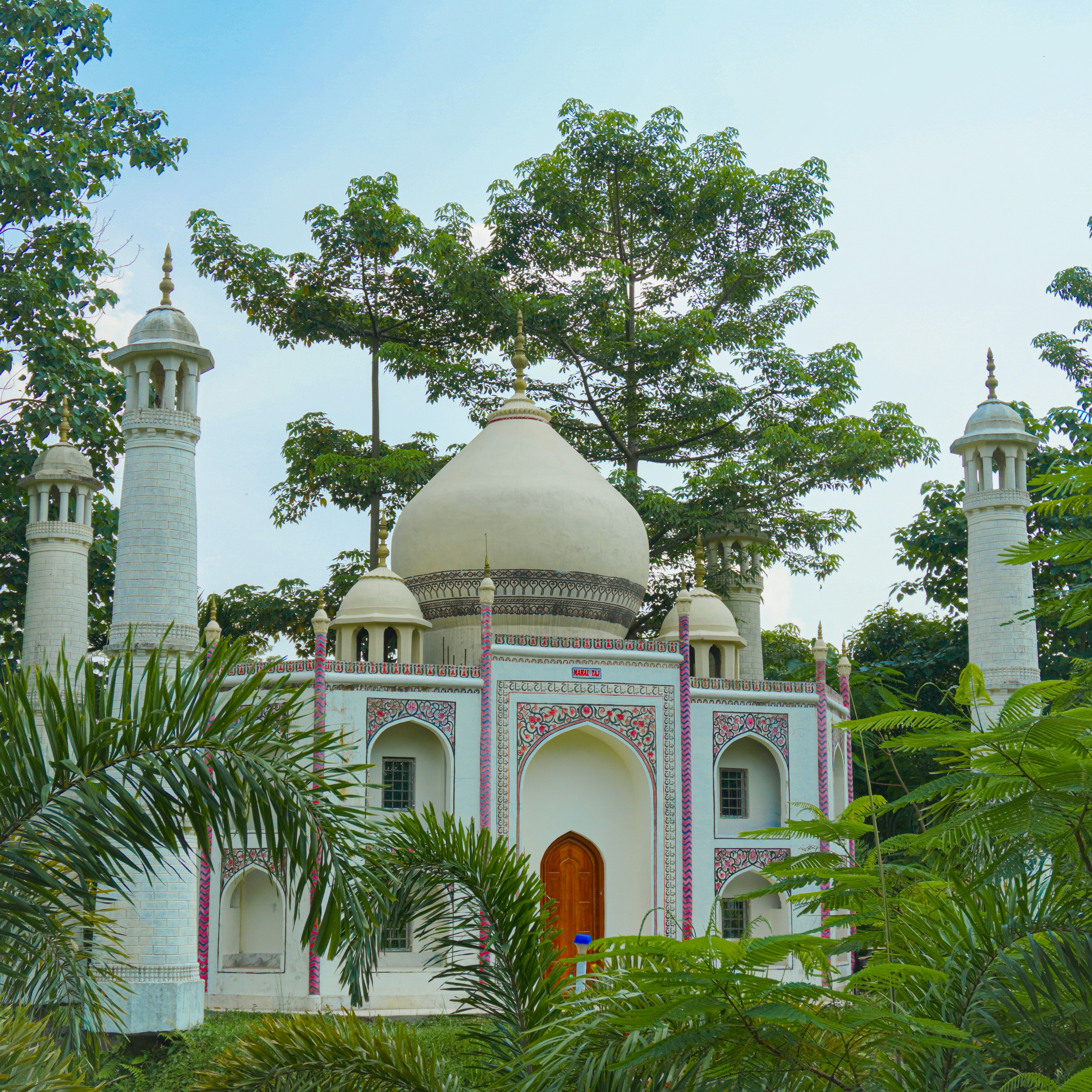 Dome-lit Shrine Framed by Fronds and Columns