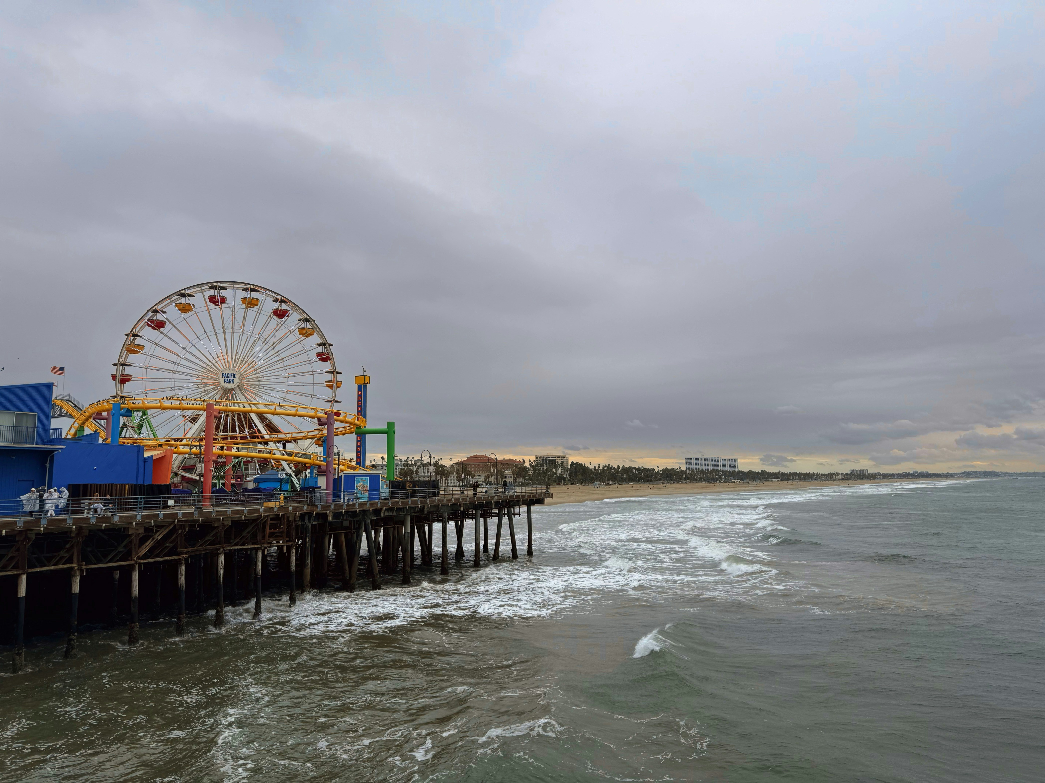 Sunlit Pier Carnival: Wheel, Waves, and Sky