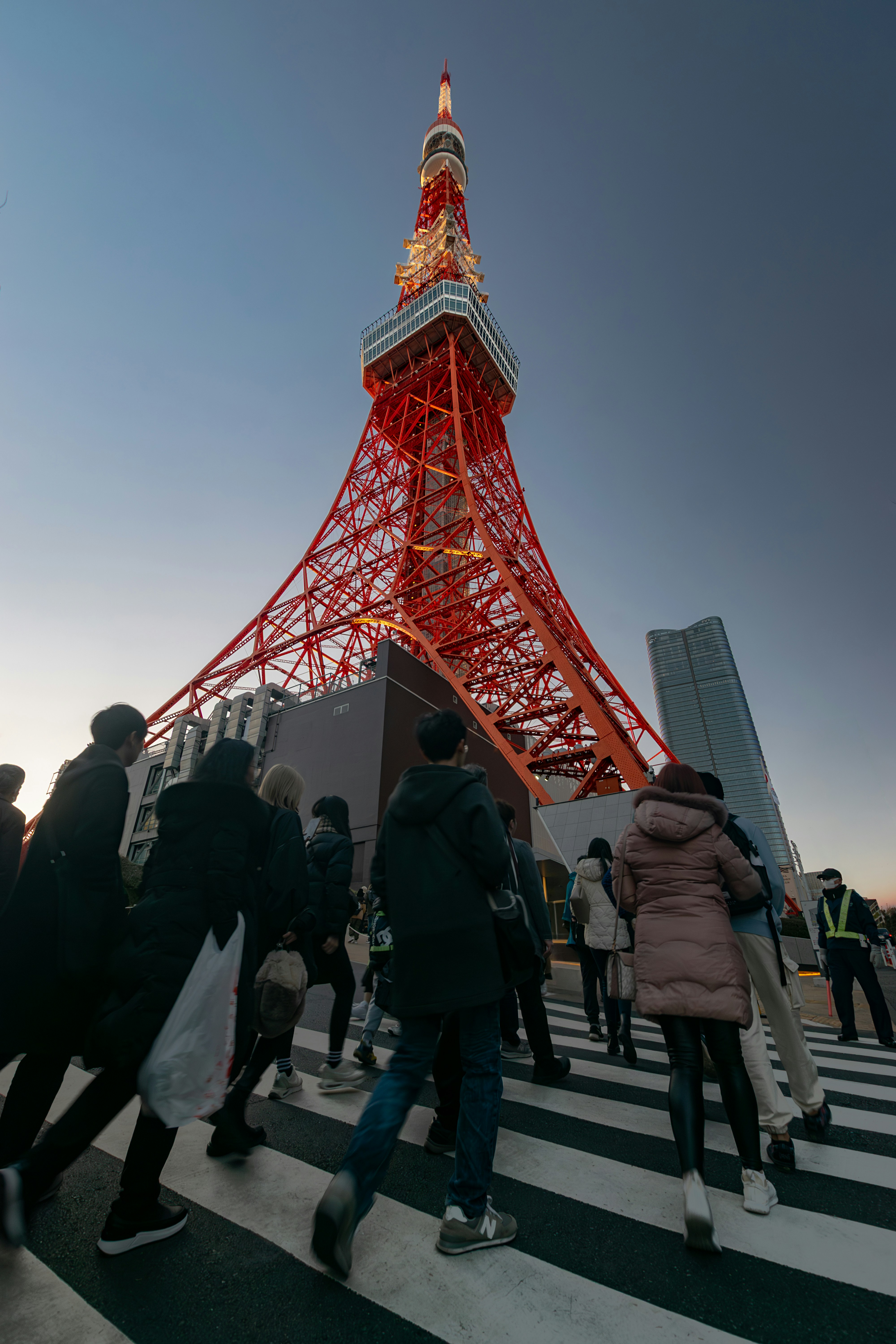 Wide angle view of people crossing the streets towards Tokyo Tower. Tokyo, Japan, Jan/24.