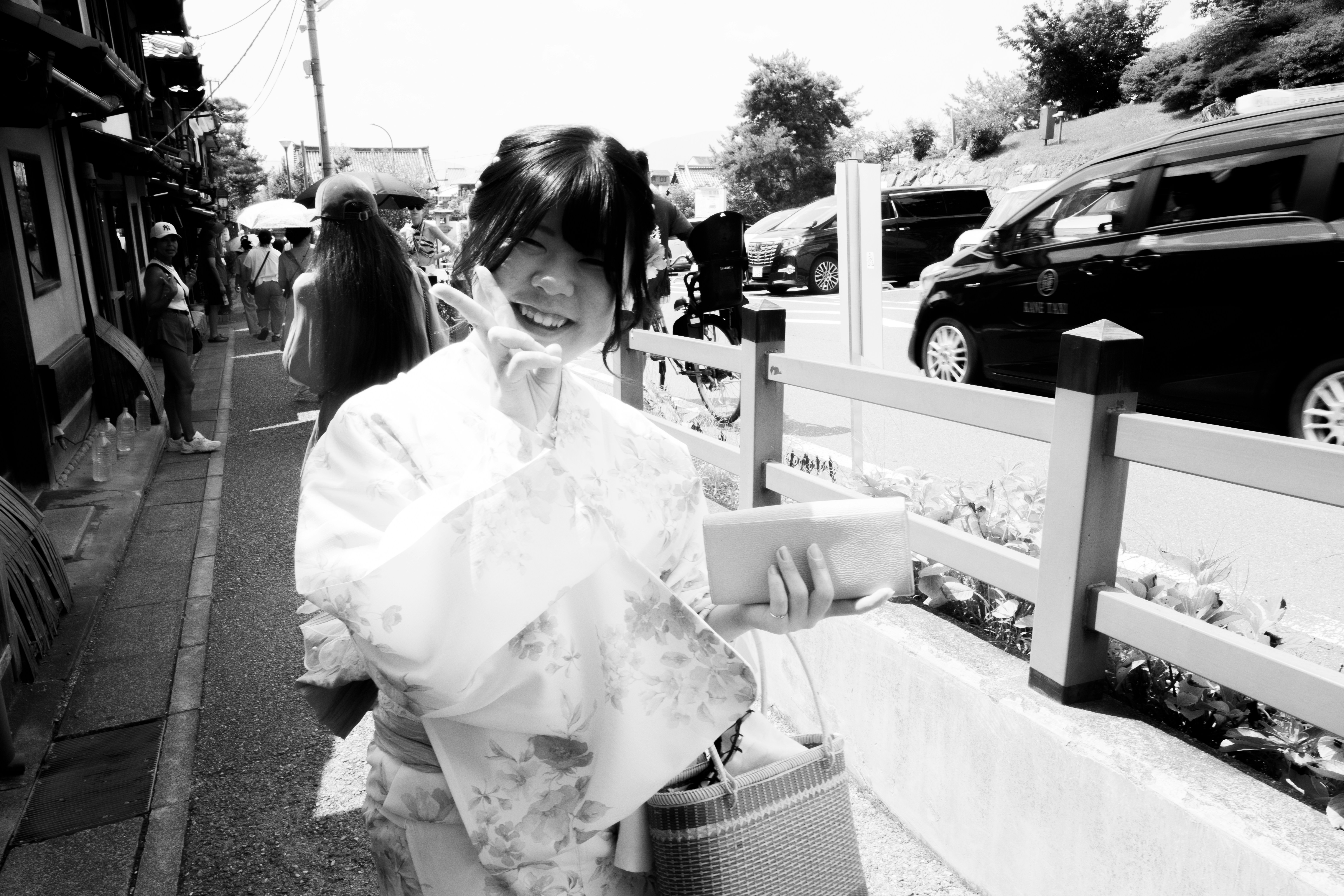 Smiling street moment: a kimono-clad passerby in motion