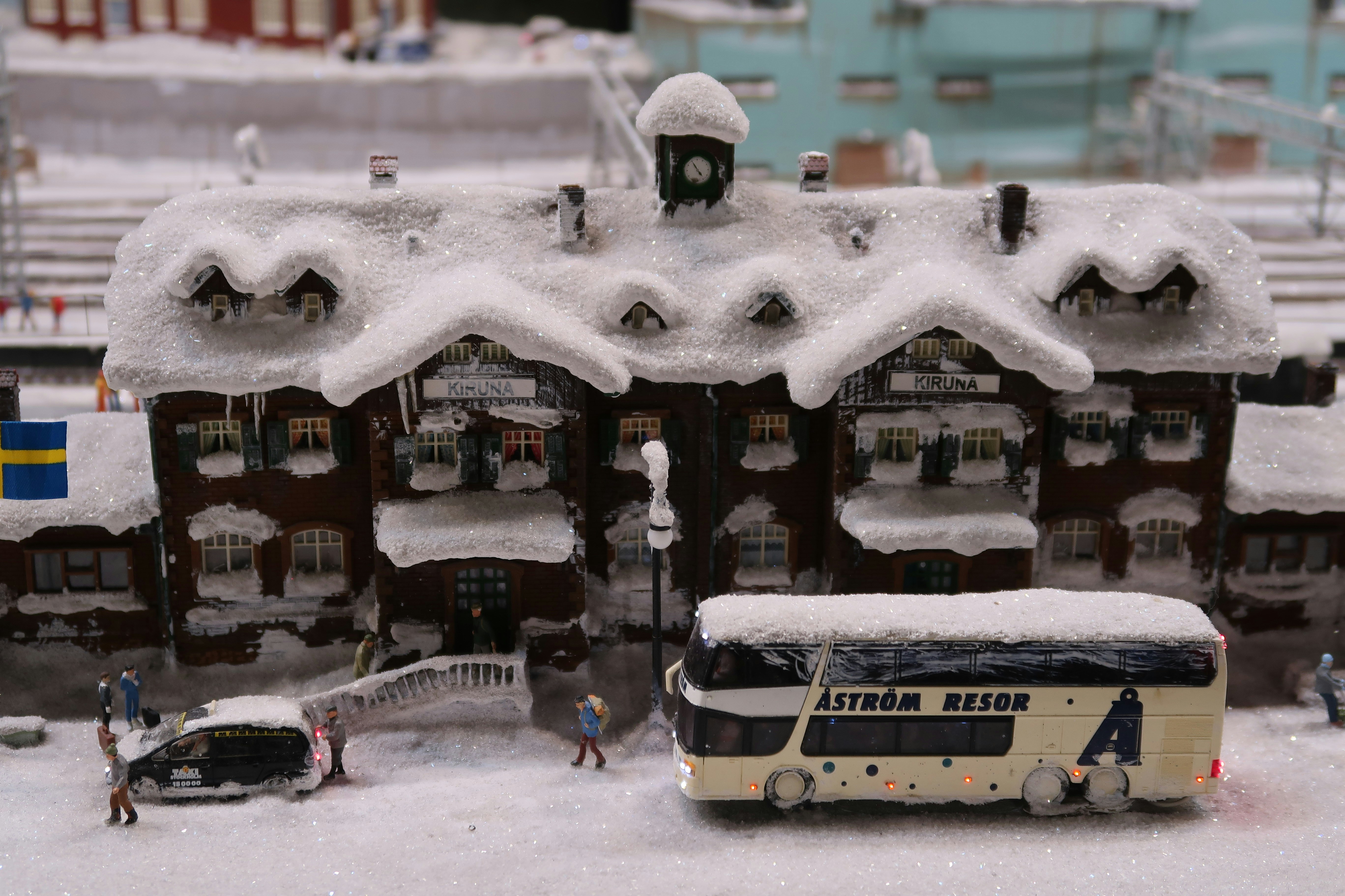 Miniature Alpine Dream: Snow-covered Chalet with Bus