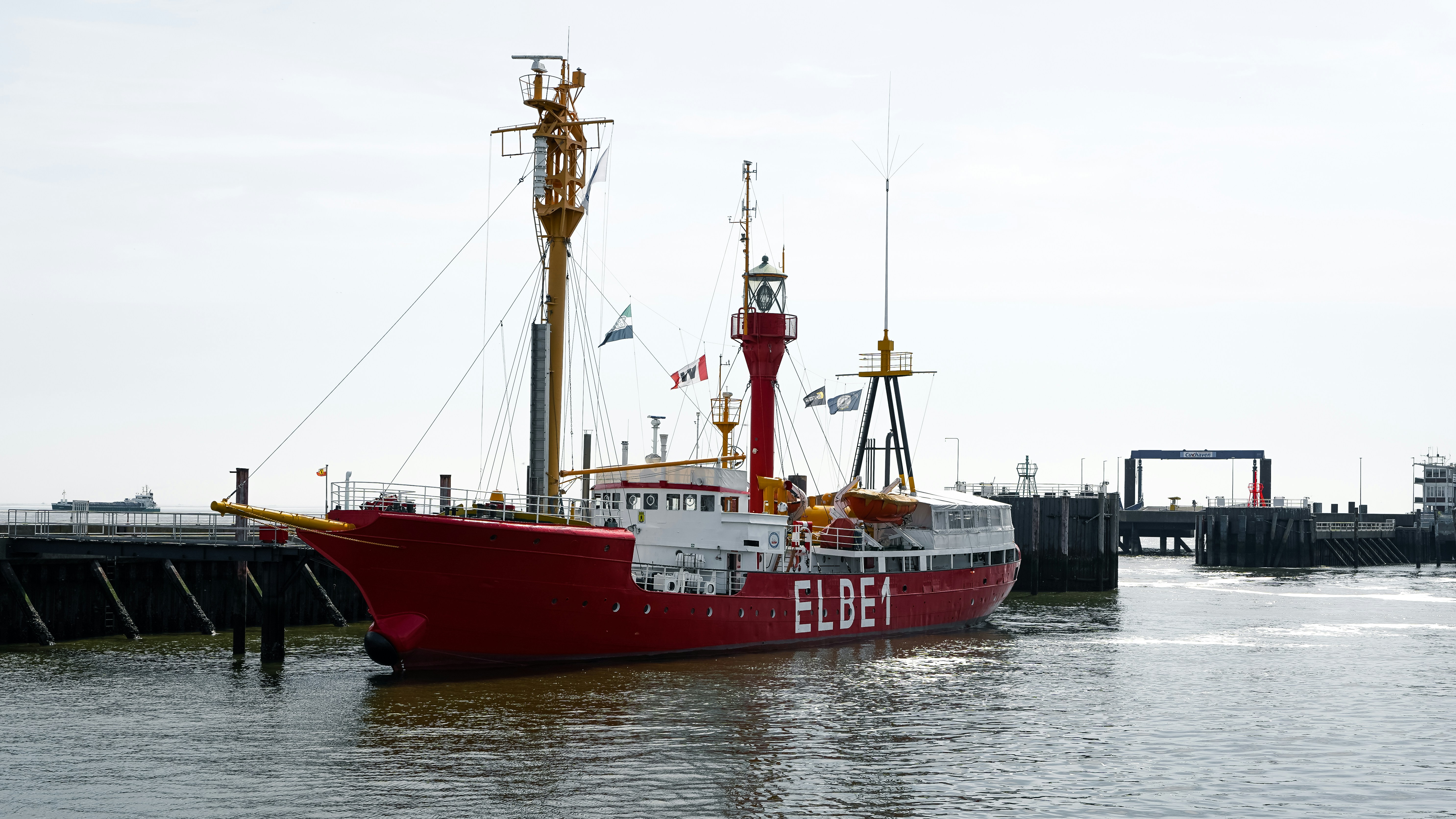 Red Harbor Vessel Anchored at Docks Under Subtle Morning Light