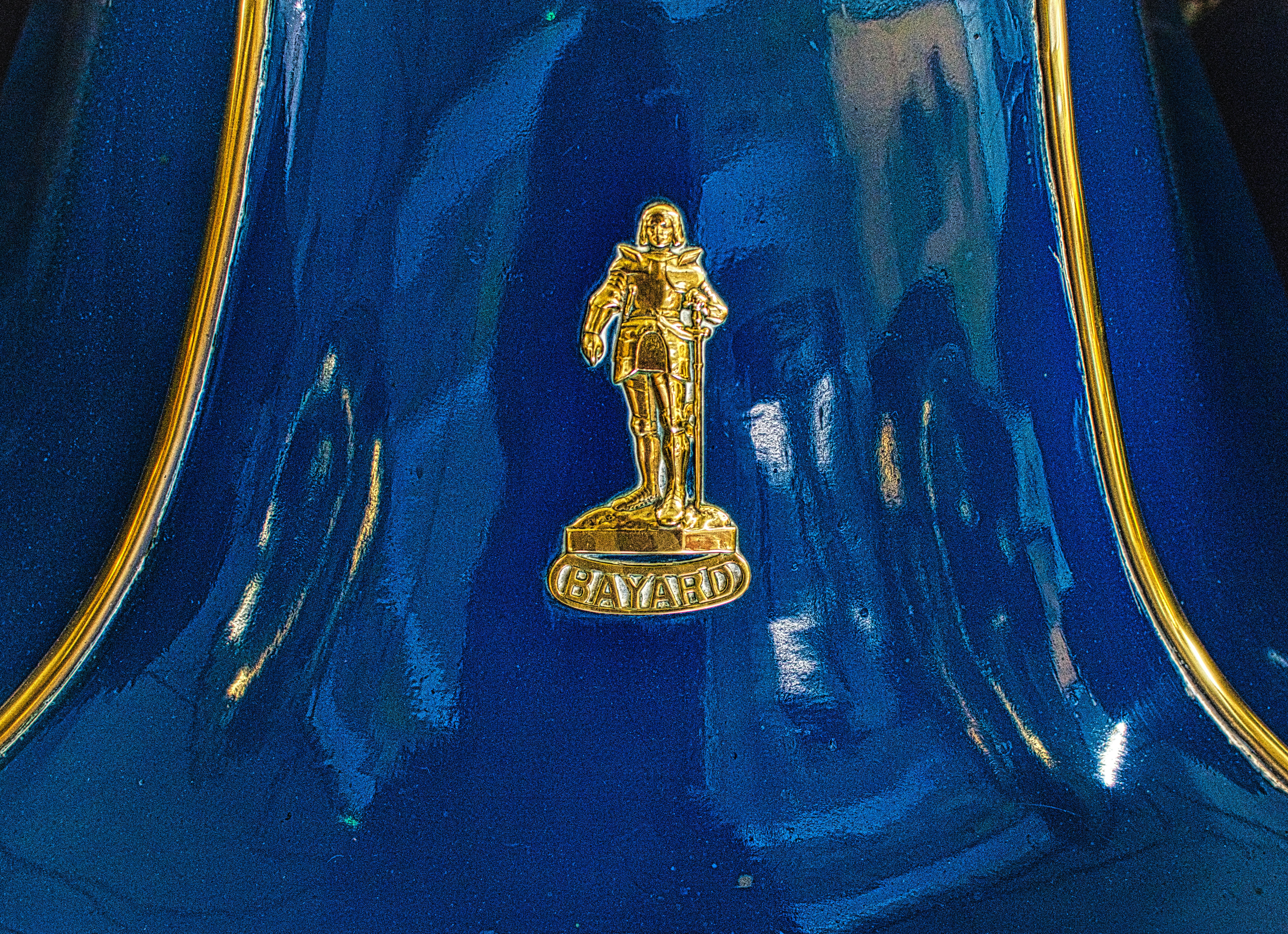 Golden Figurine On a Regal Blue Pedestal