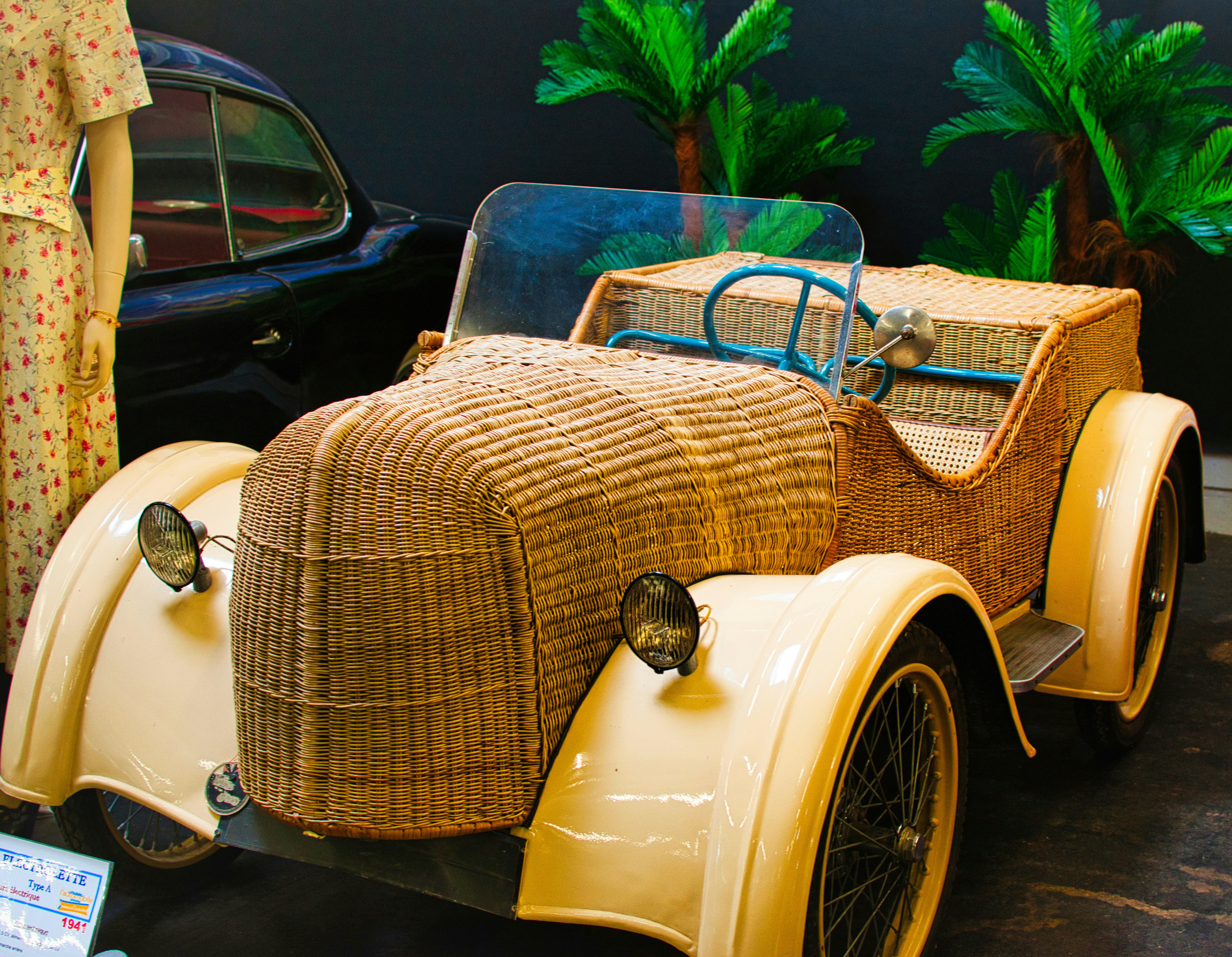 Wicker-Wheeled Vintage: A Creamy Convertible in a Timeless Display