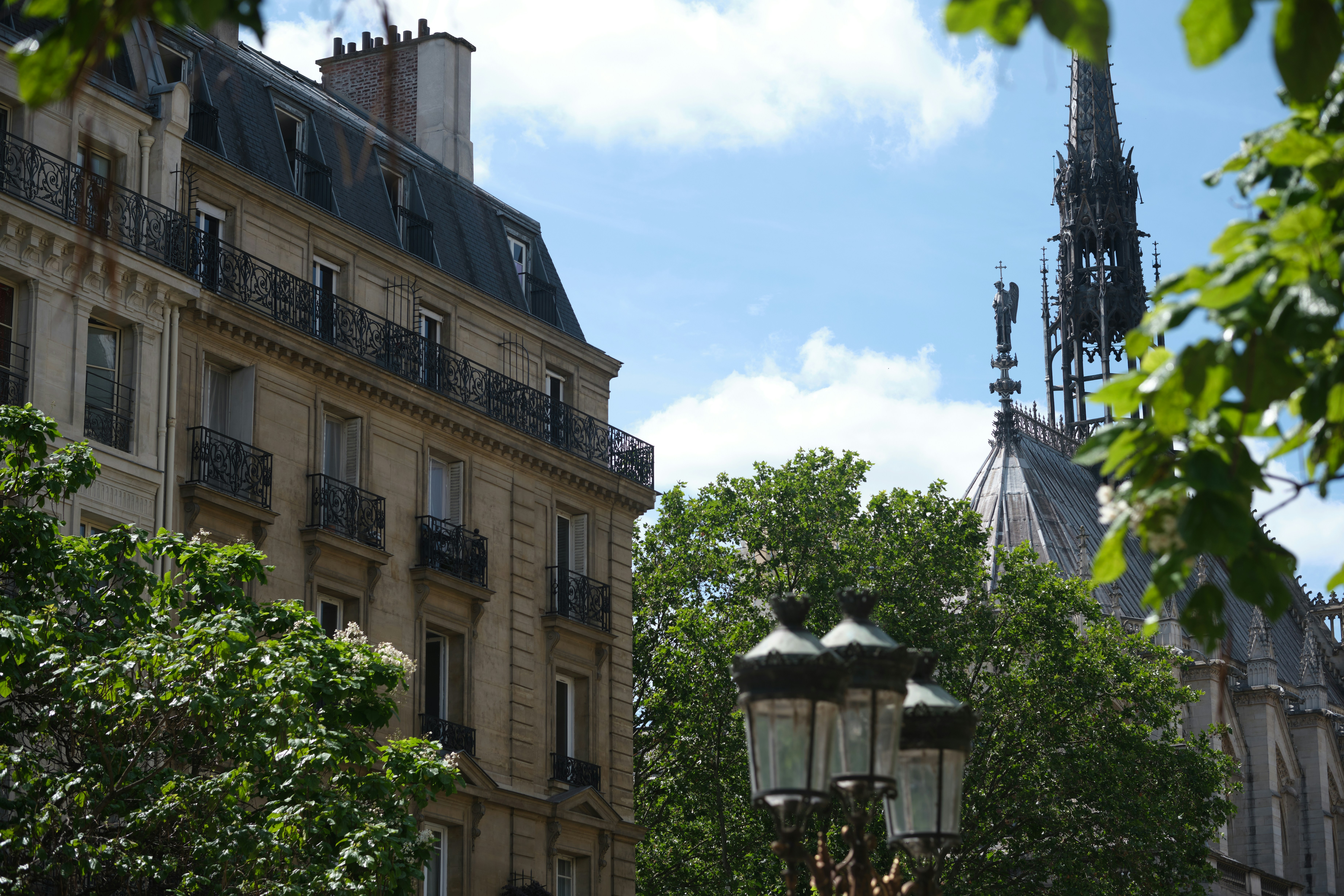 Parisian Rooftops and Spire: Urban Quiet Under a Bright Sky