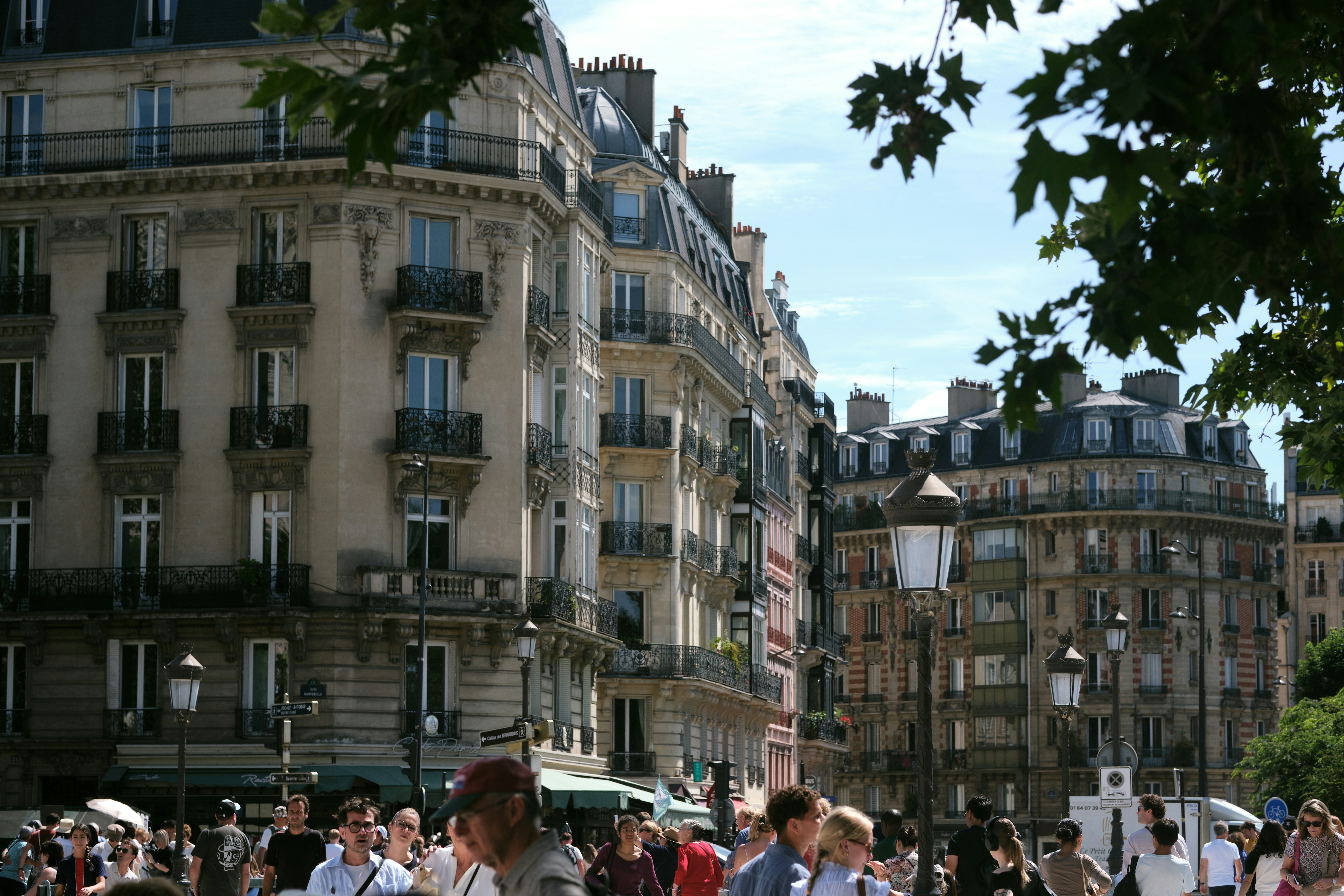 Parisian street scene with historic buildings and people.