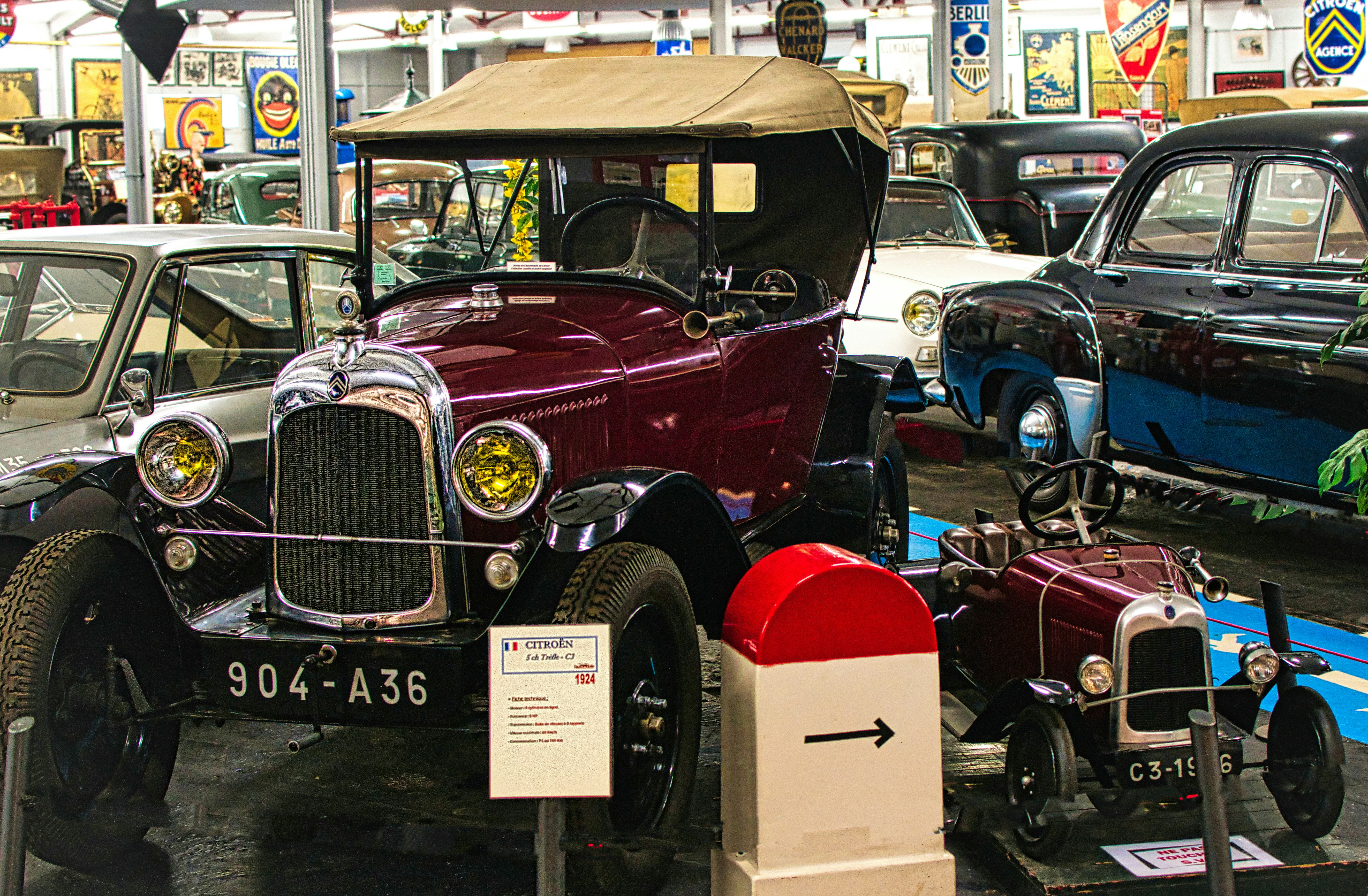 Vintage Car Court: A Burgundy Convertible and its Tiny Companion