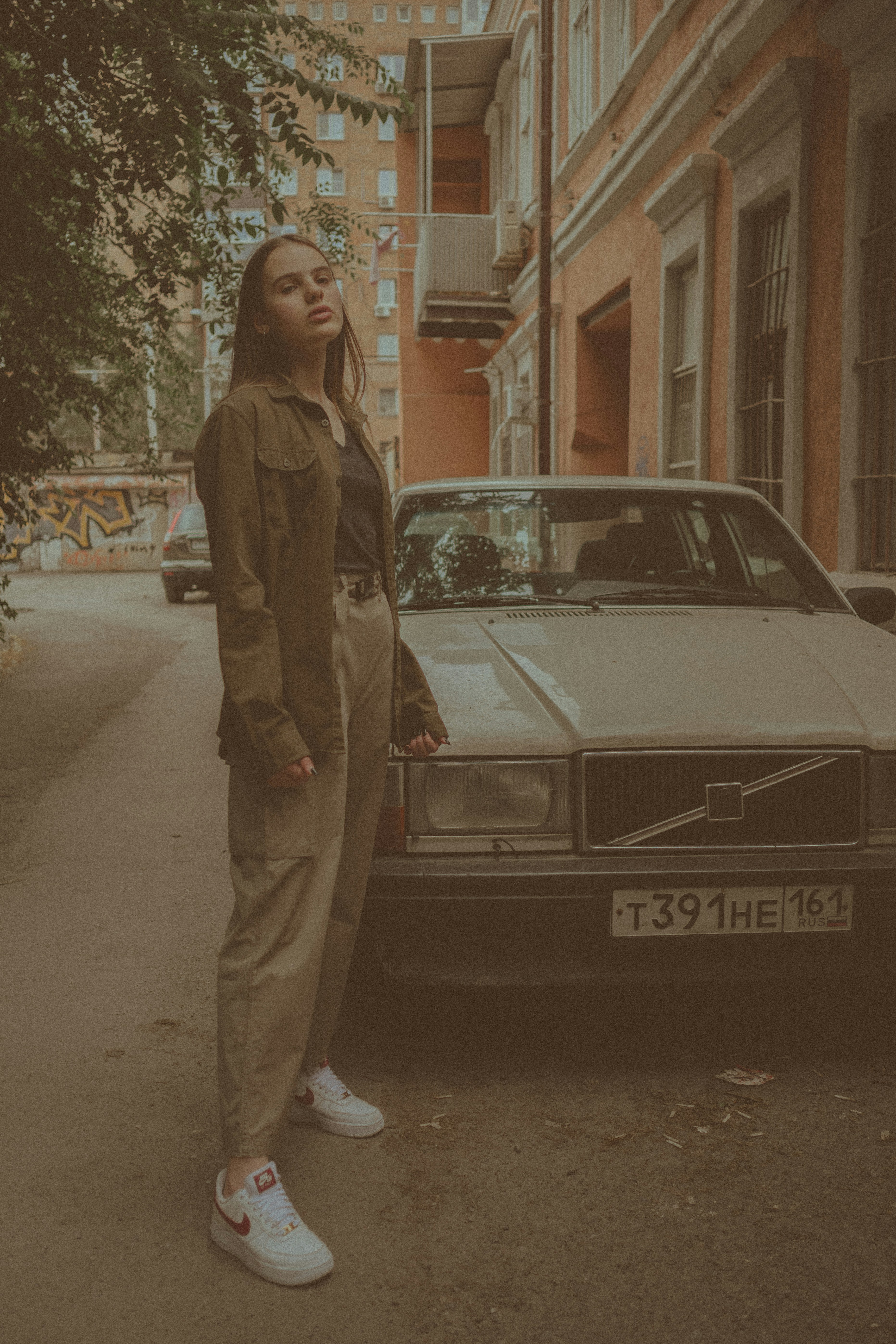 Urban Portrait at Dusk: A Quiet Stance by the Volvo