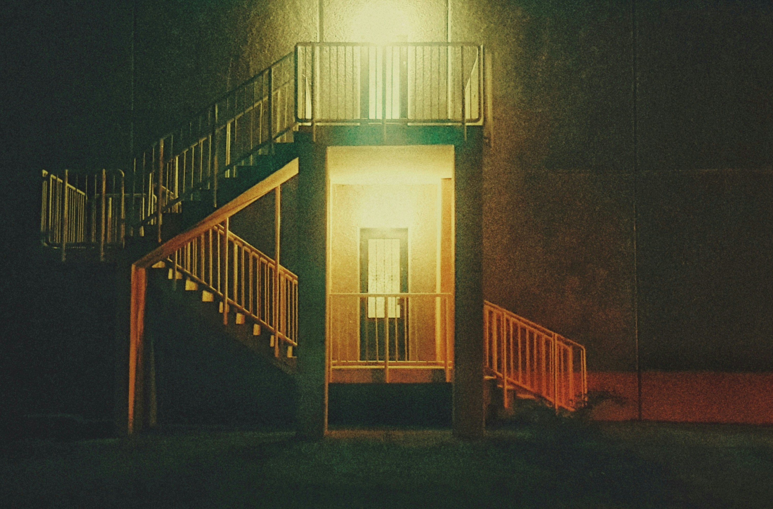 An outdoor staircase illuminated by a single light at night.
