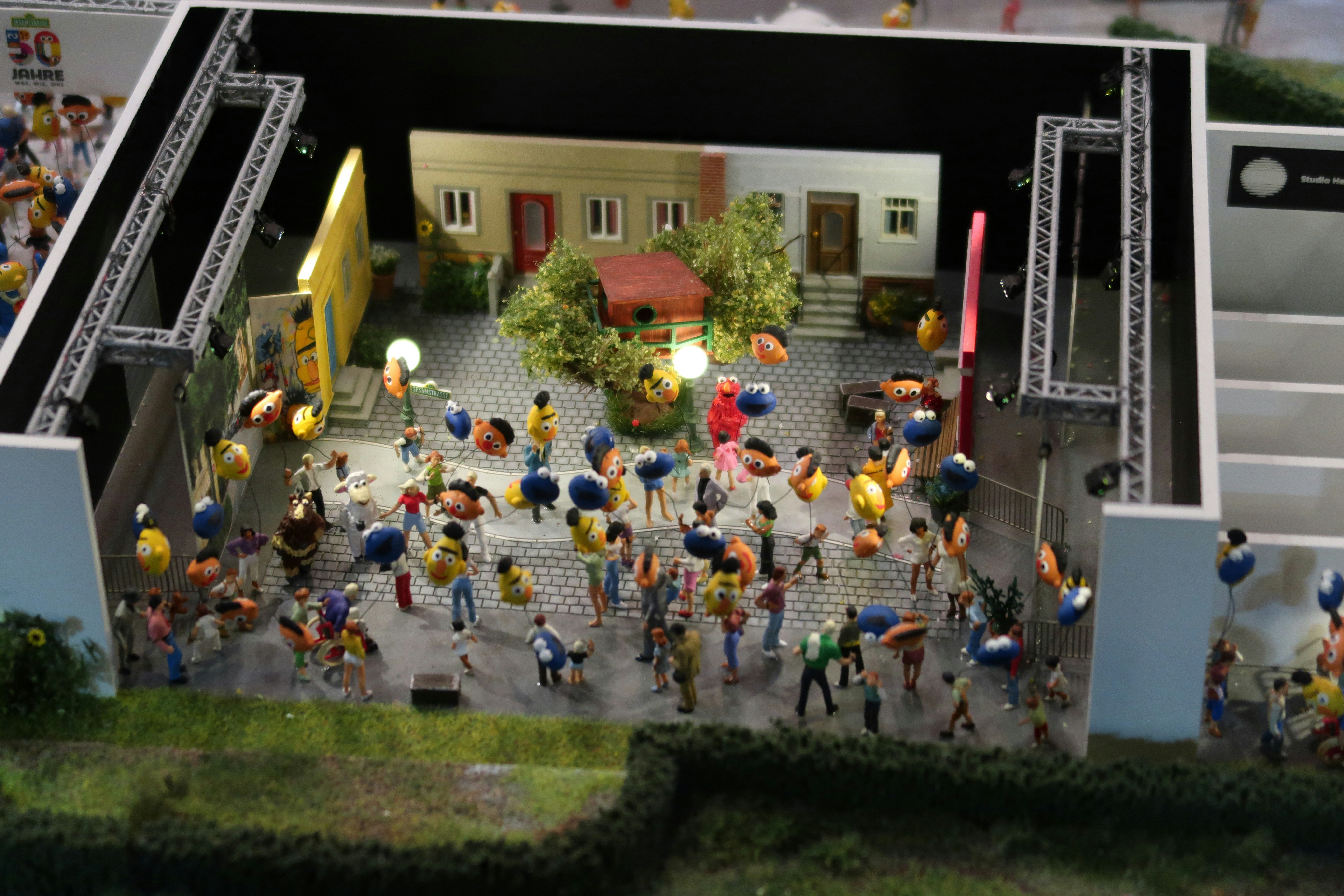 Miniature crowd surge in a dollhouse amphitheater