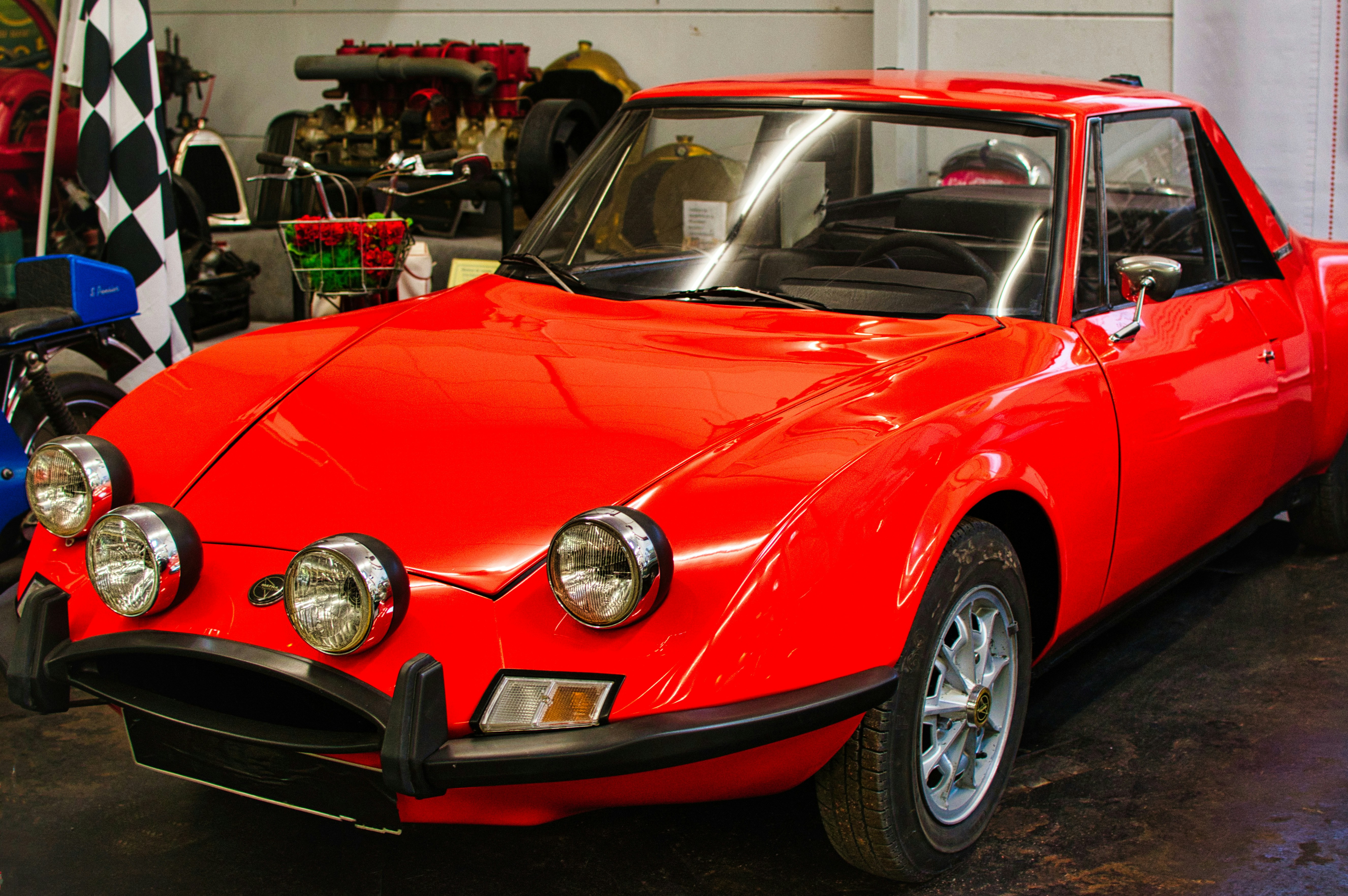Vivid Red Classic: A Vintage Triumph Resting in a Workshop