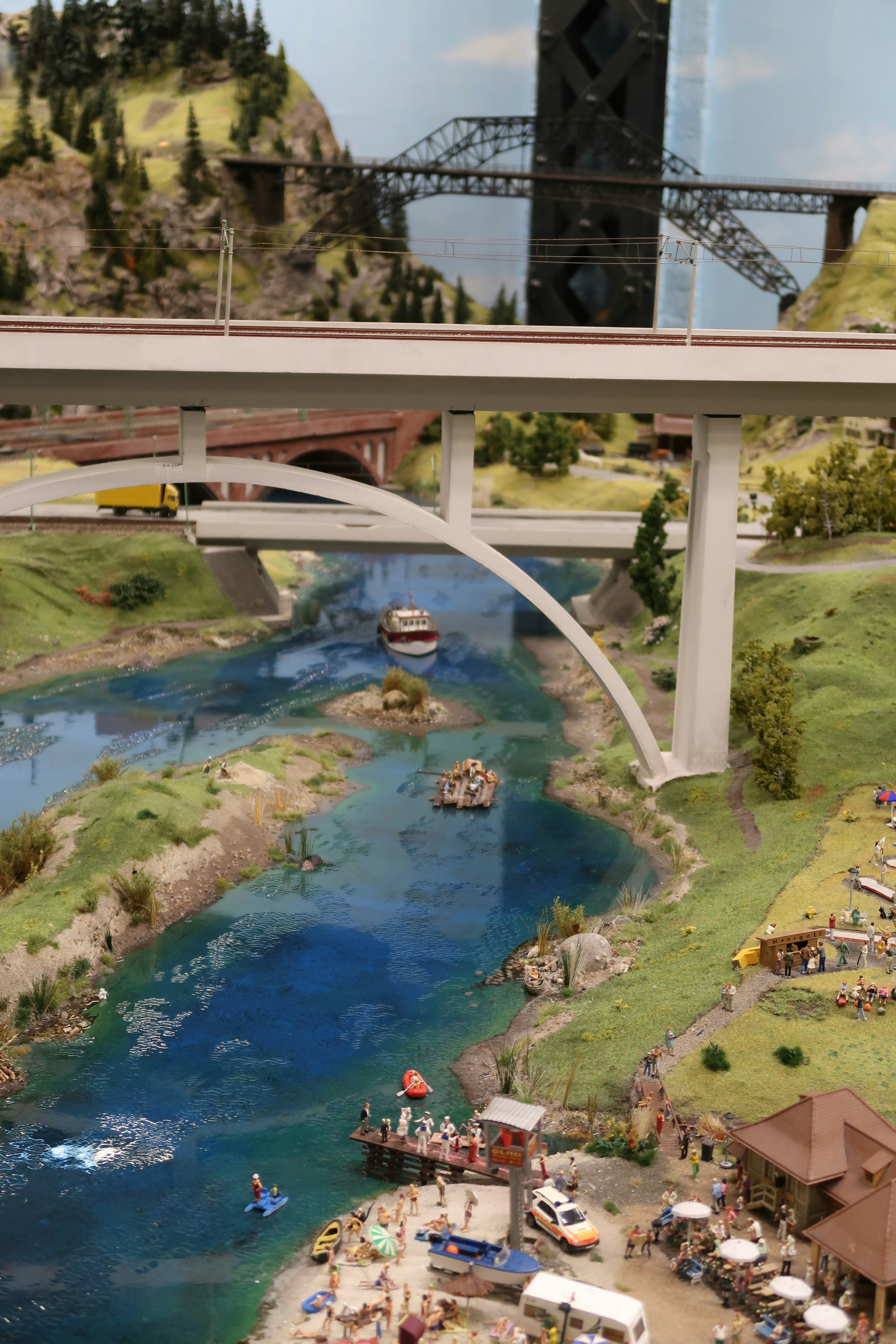Miniature River Parade under a White Arch: A Day by the Model Canal