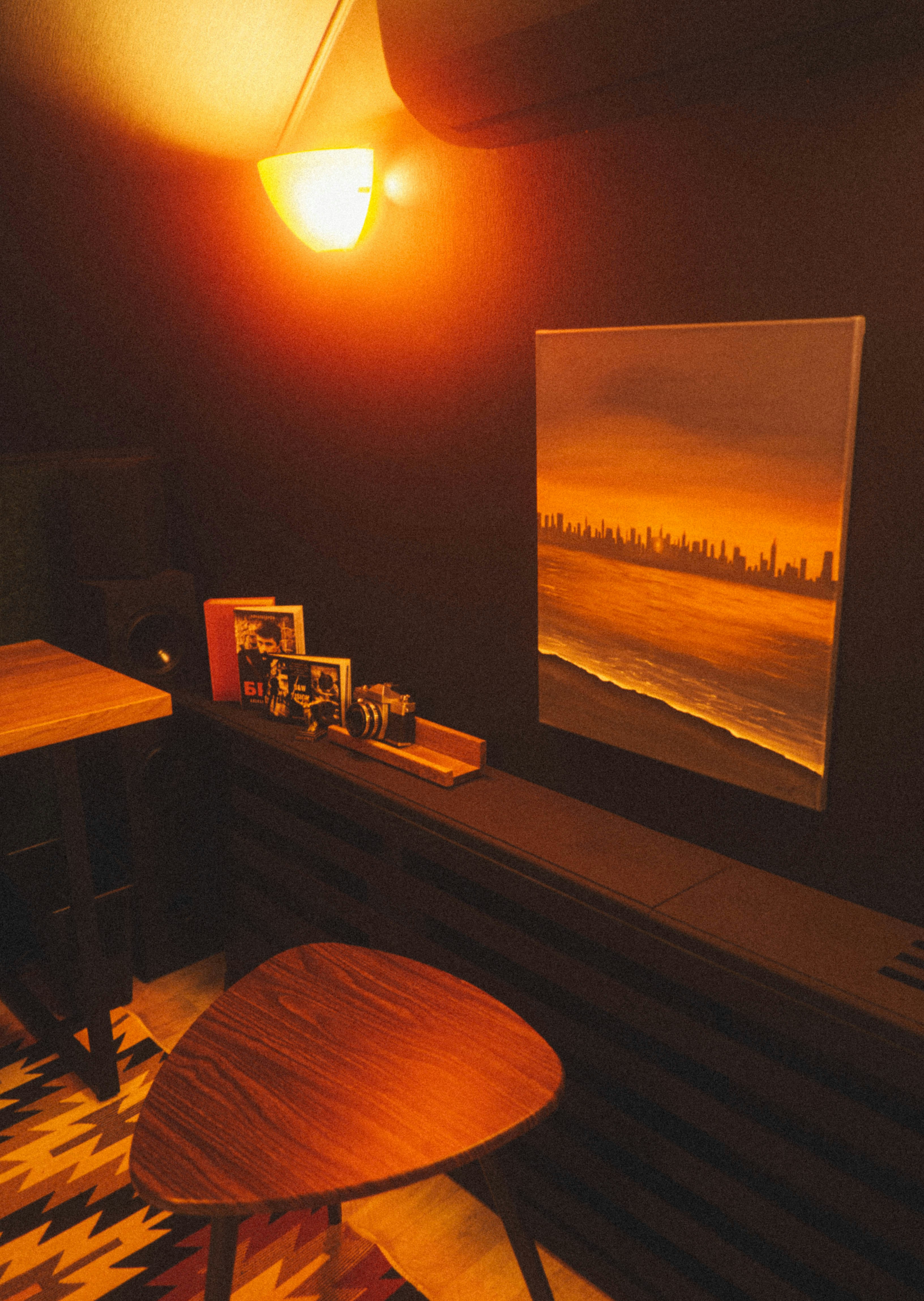 Amber Quiet: A Corner Studio Glow with Sunset Portrait on the Wall