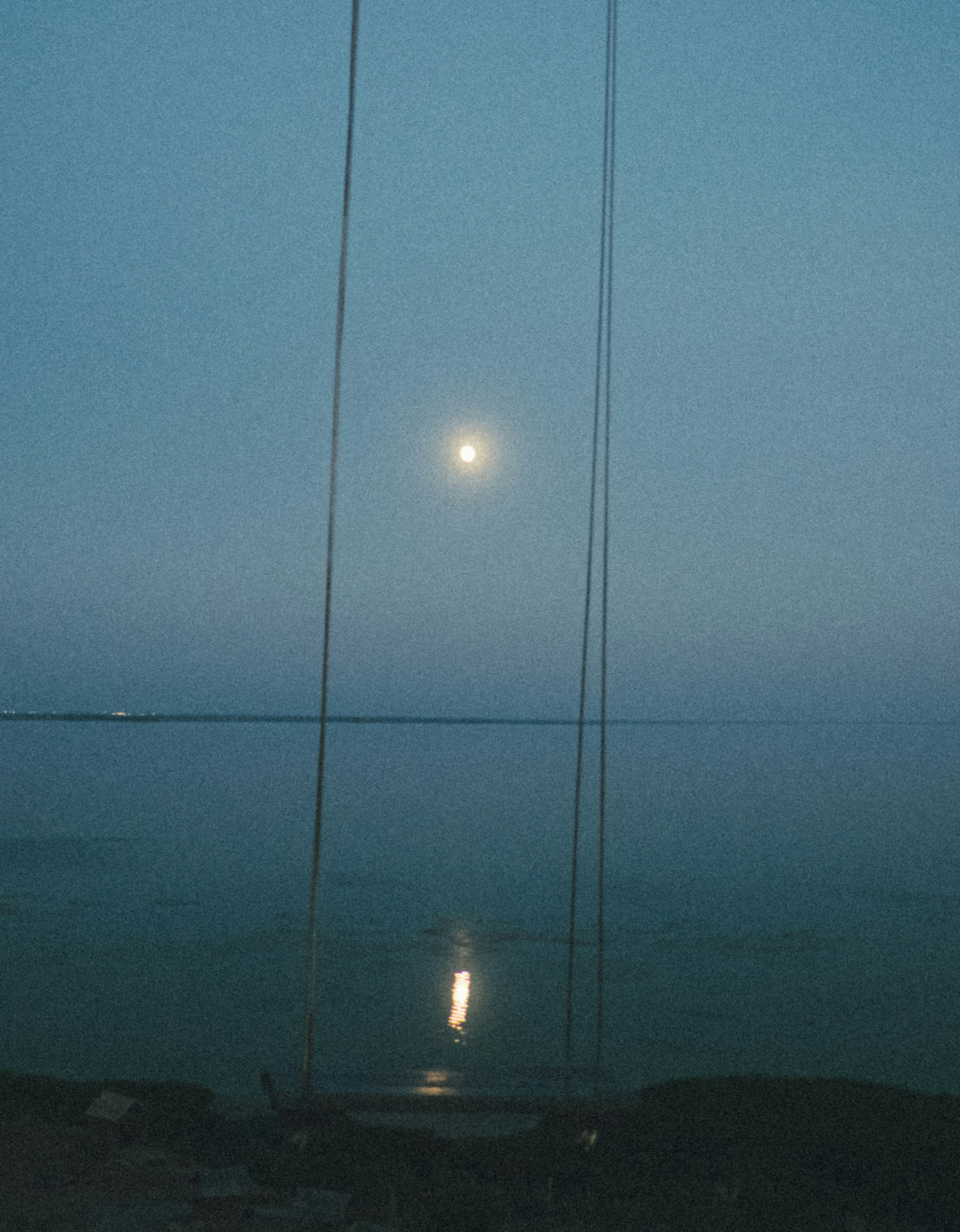Moonlit Swing Over a Quiet Sea