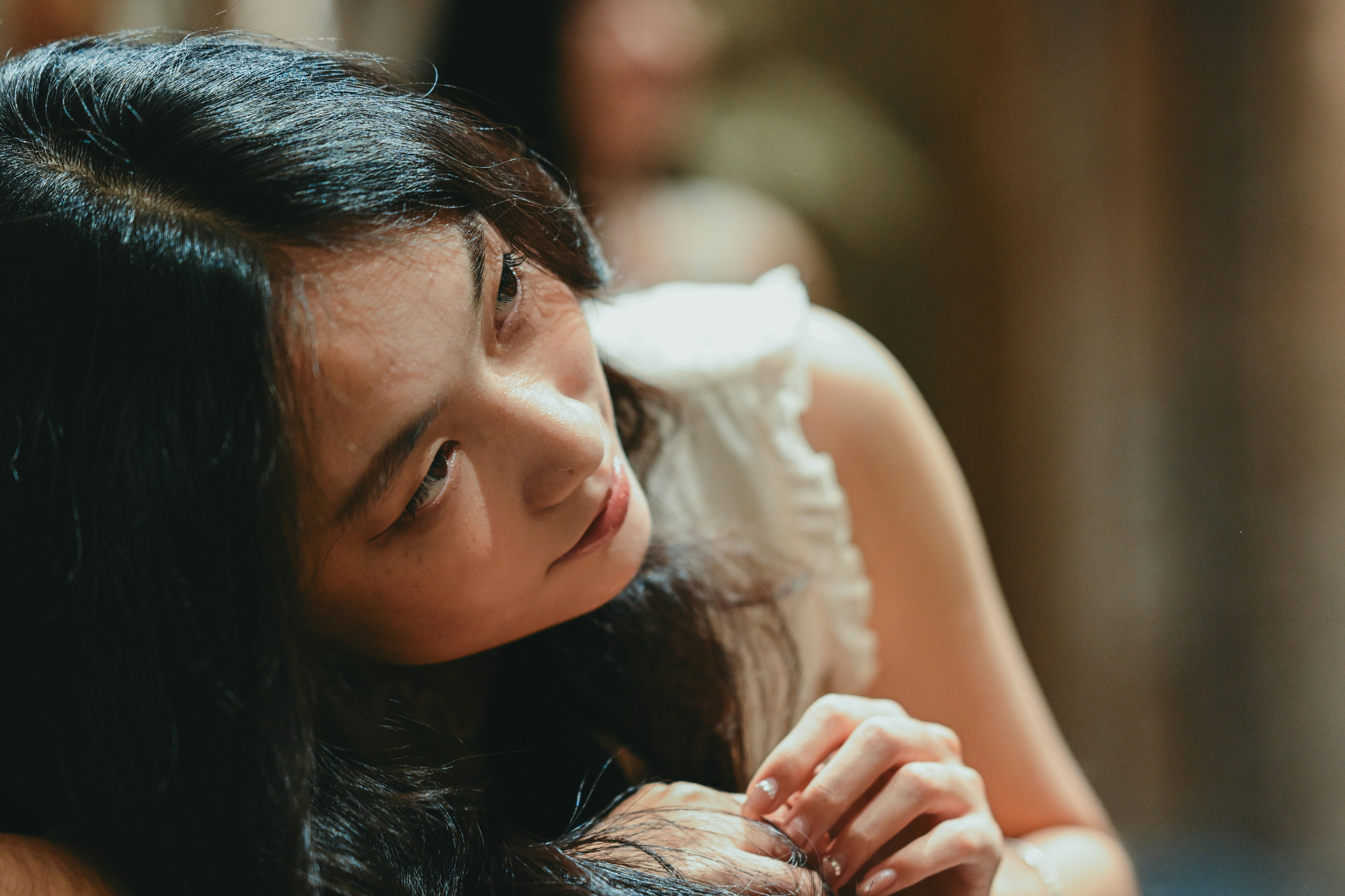 Soft Focus, Quiet Moment: A Woman Lost in a Gentle Thought
