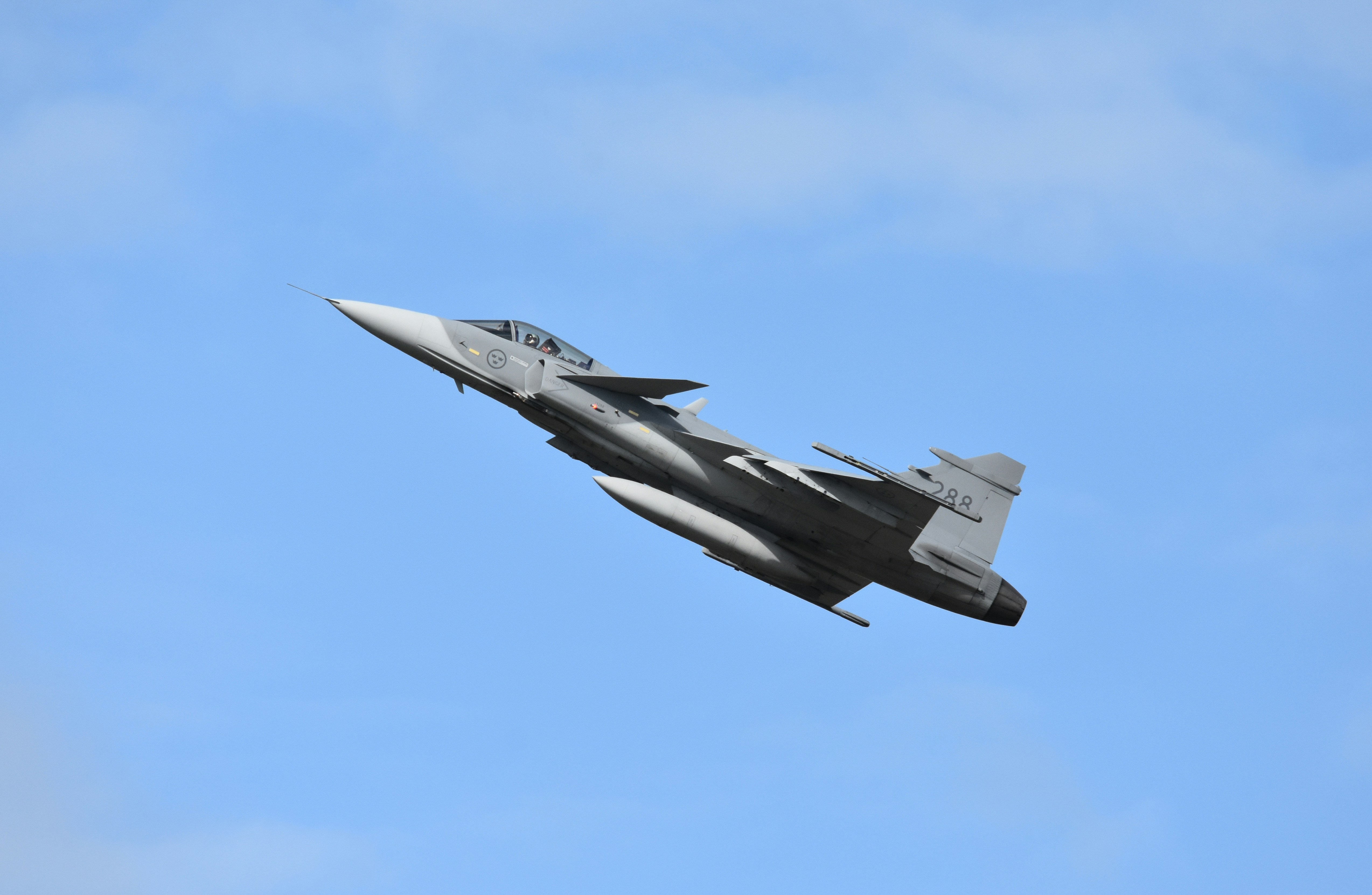 Skybound delta: a stealthy jet arcs through a clear blue