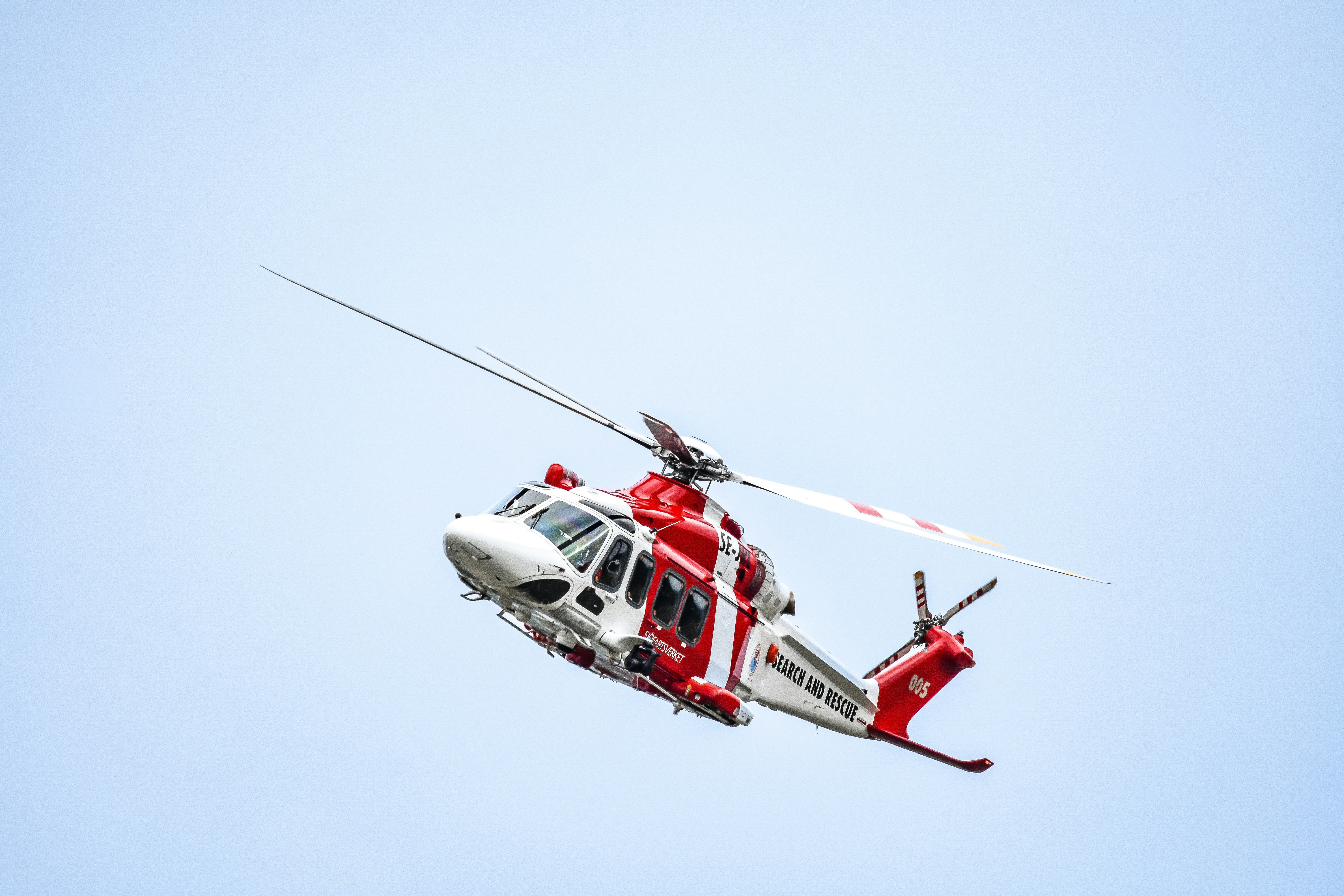 Emergency Helipad in the Sky: A Red-White Rescue Rotorcraft in Flight