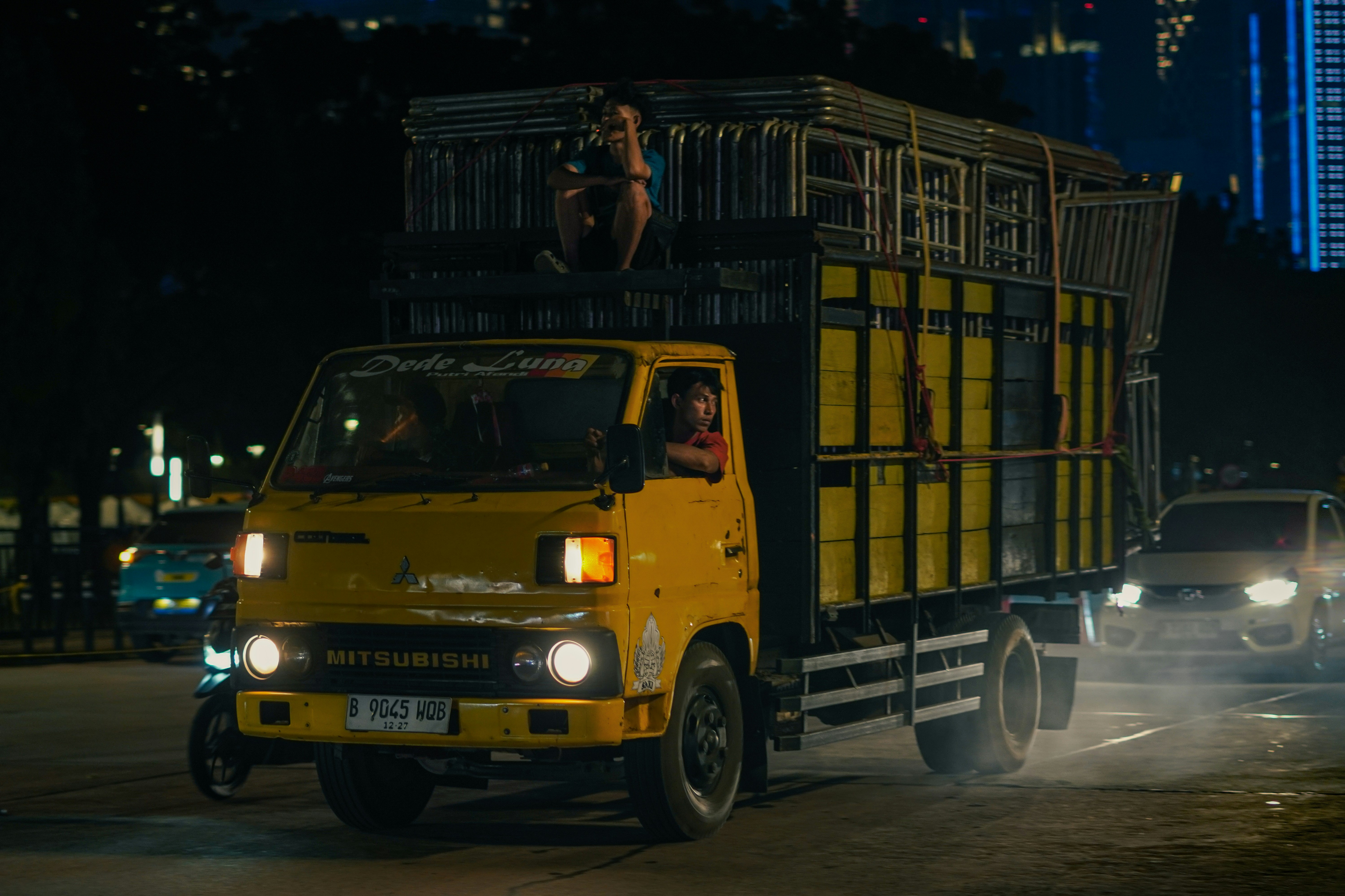 Night Freight: A Yellow Truck Carries the City at Dusk
