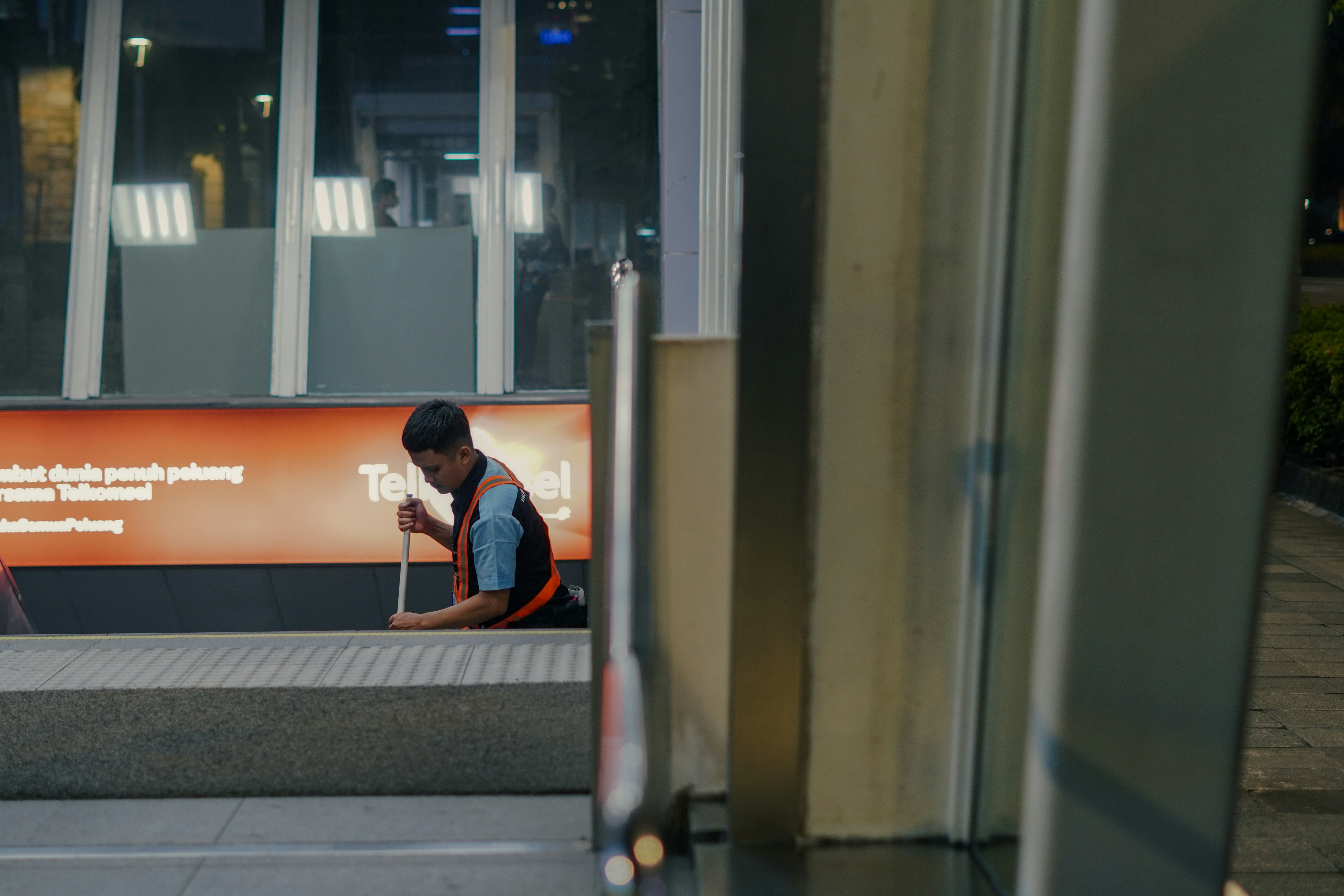 Night Shift at the Terminal: A Worker Garners Focus in a Silent Platform