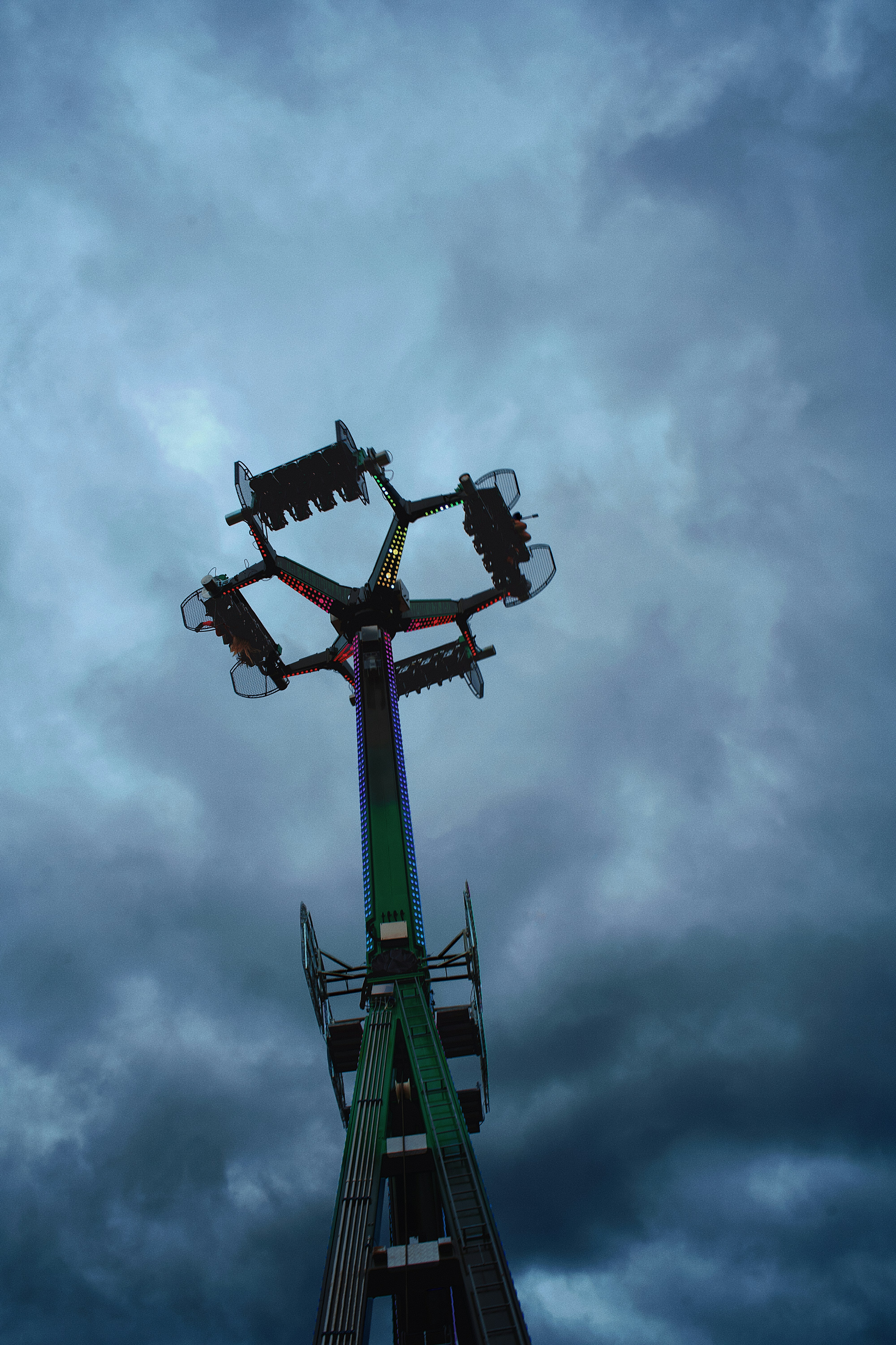 Aerial carnival ride cuts through stormy skies