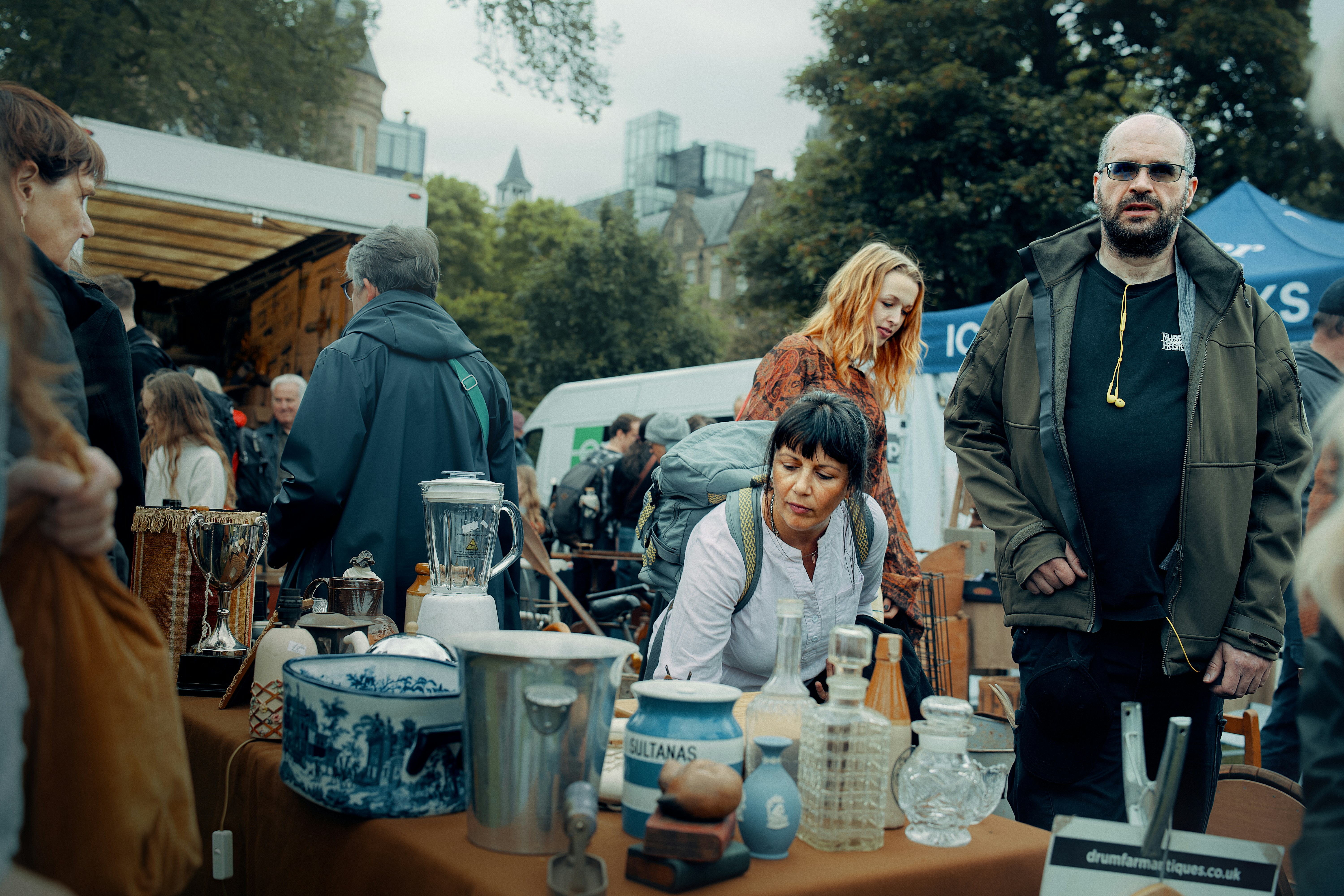 Market stall and bystander crowd at a lively outdoor fair
