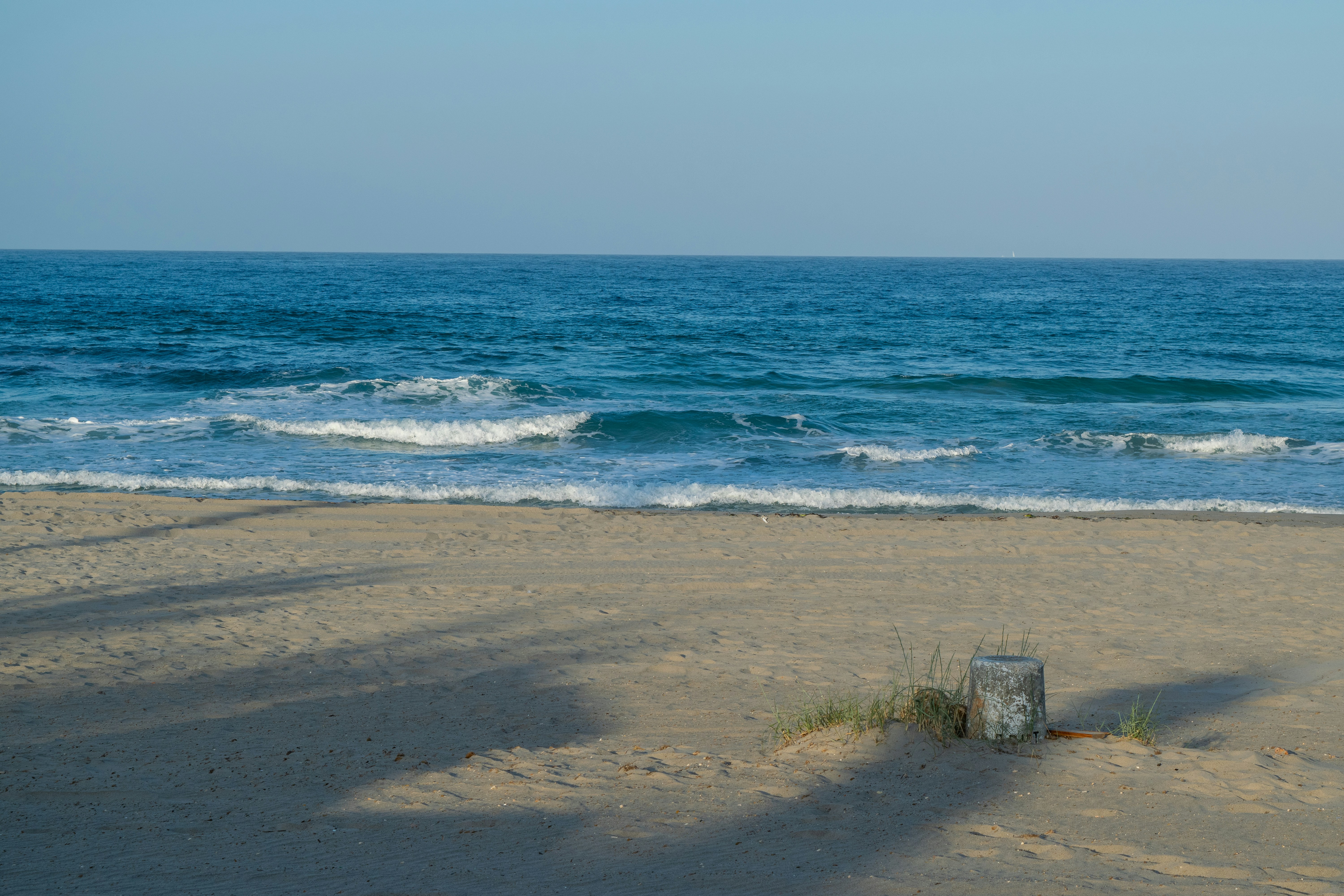 Horizon Pulse: Calm Sea with Shadowed Beach