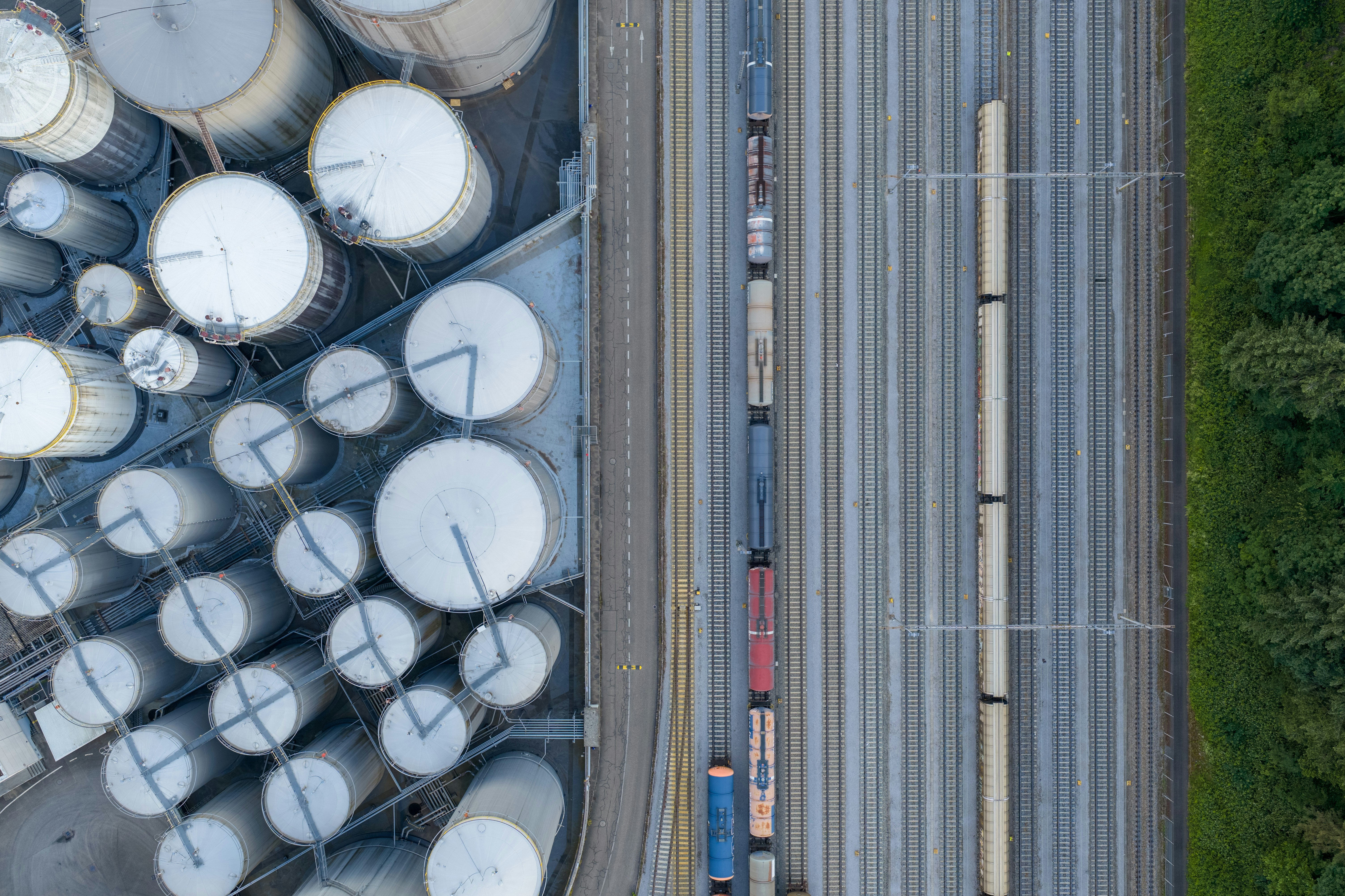 Industrial Staircase of Freight Rails: Aerial Symphony of Silos and Tracks