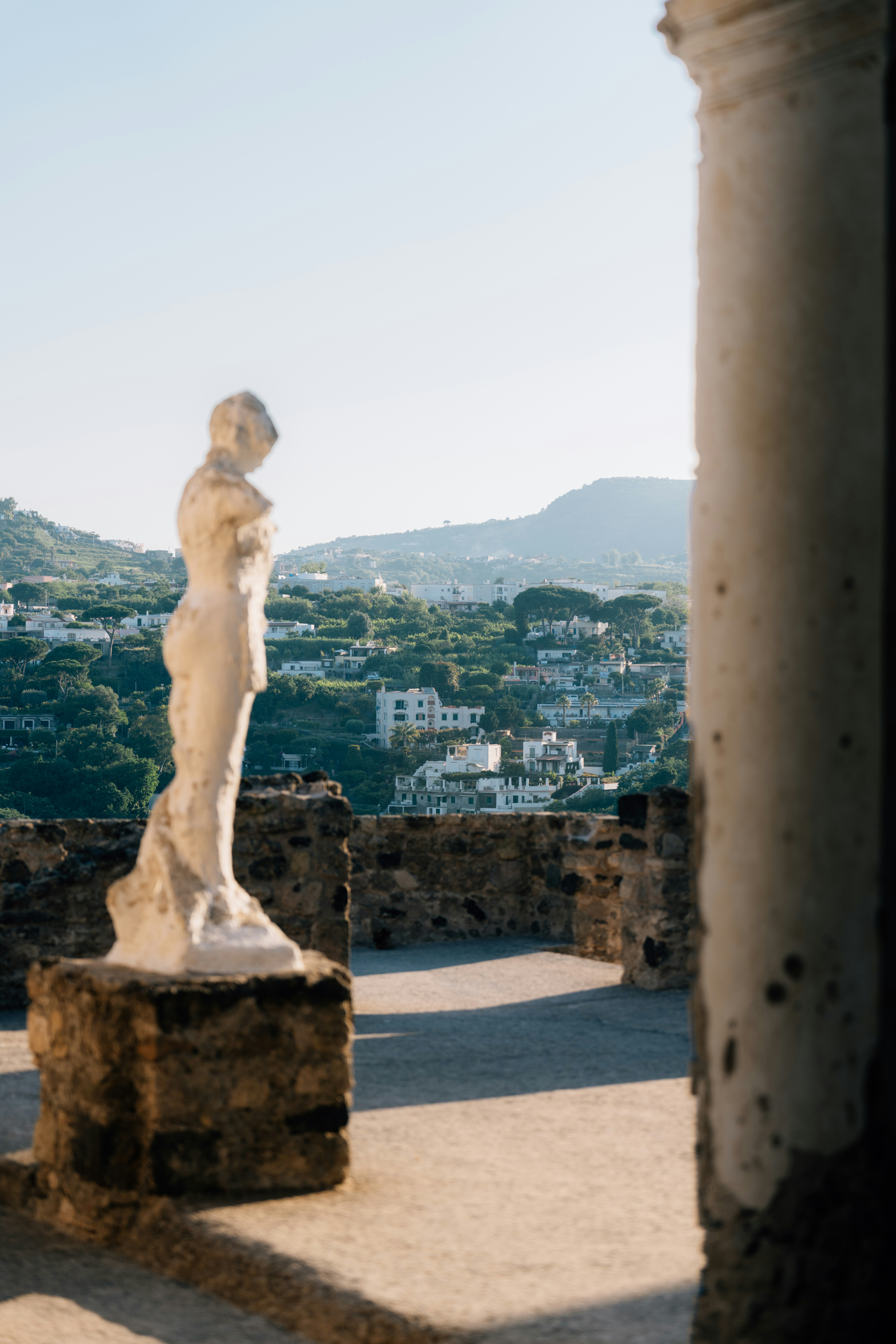 Statue Silhouette at a Mediterranean Terrace Overlooking Town