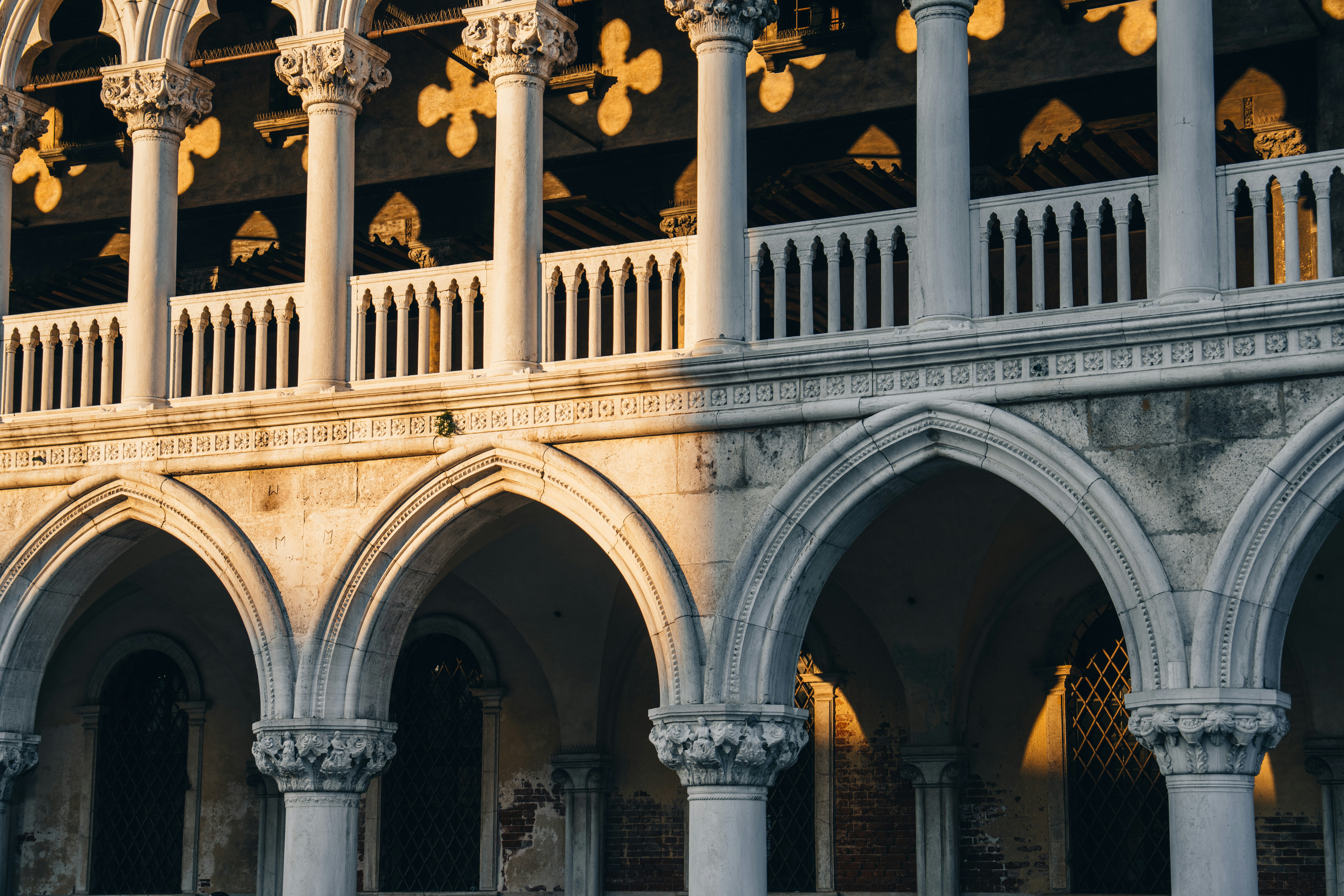 Sunlit Colonnade: Golden Light on Rustic Arches