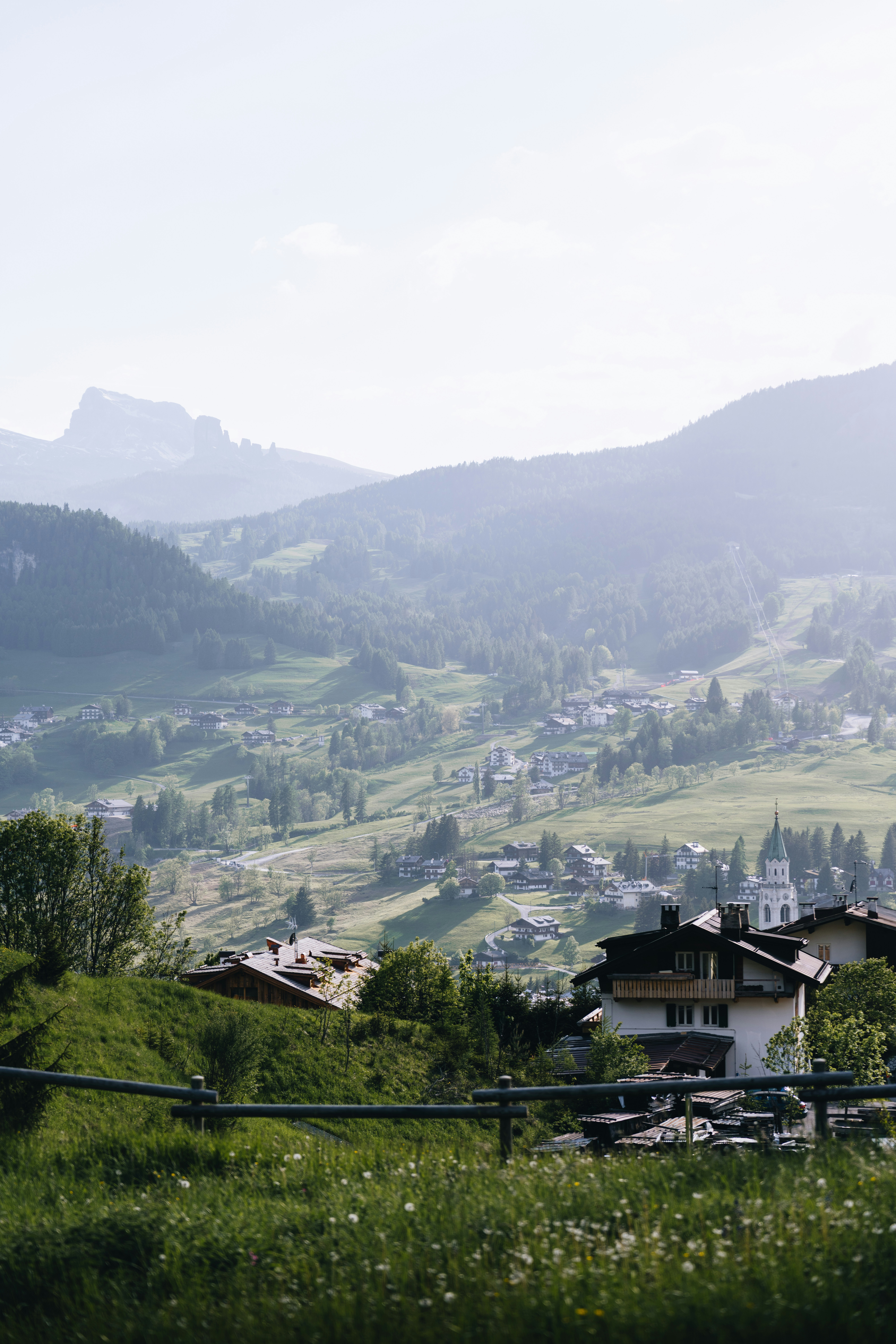Scenic view of a village in a green mountain valley.