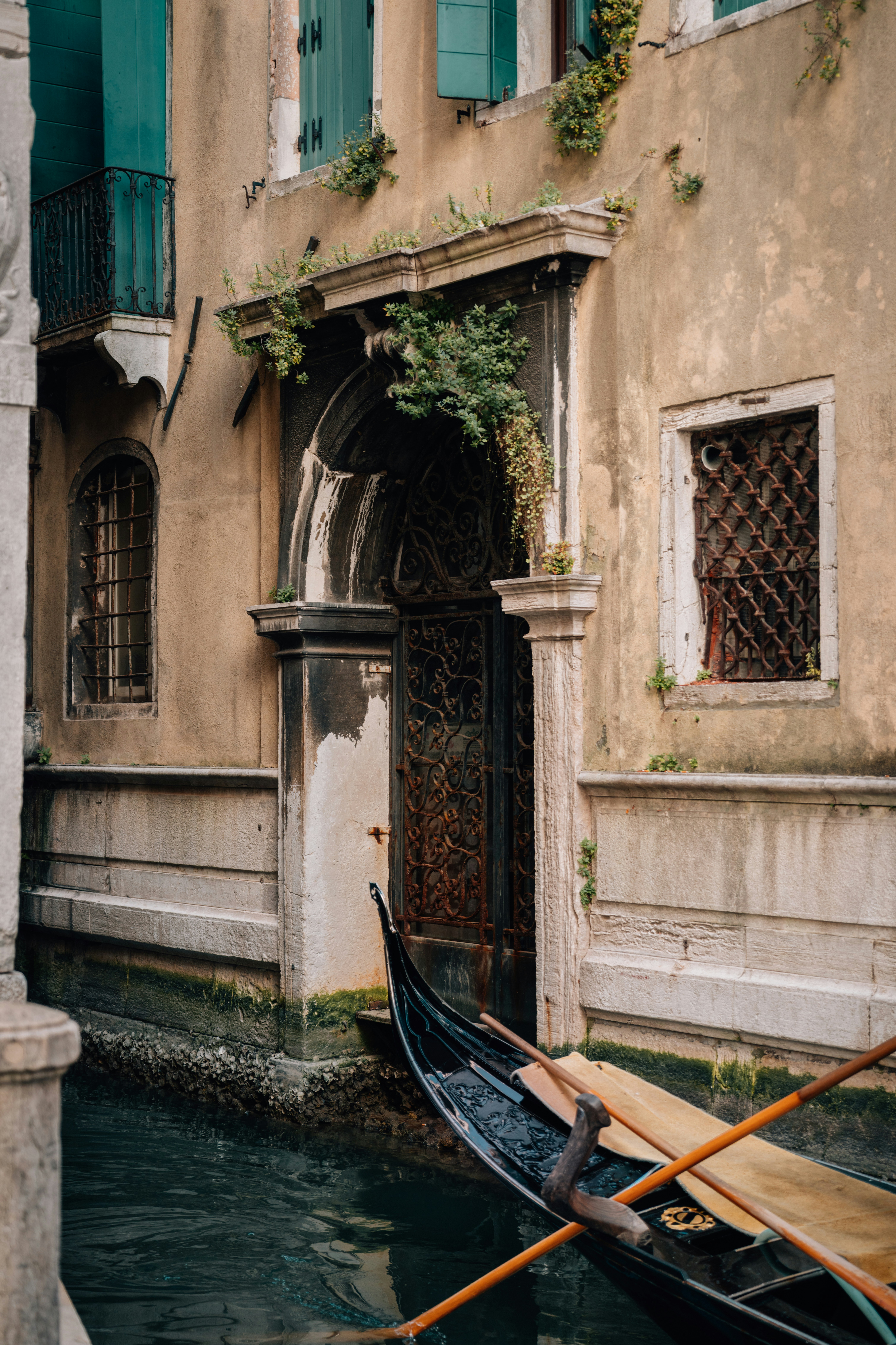 A gondola docked beside an old building in venice.