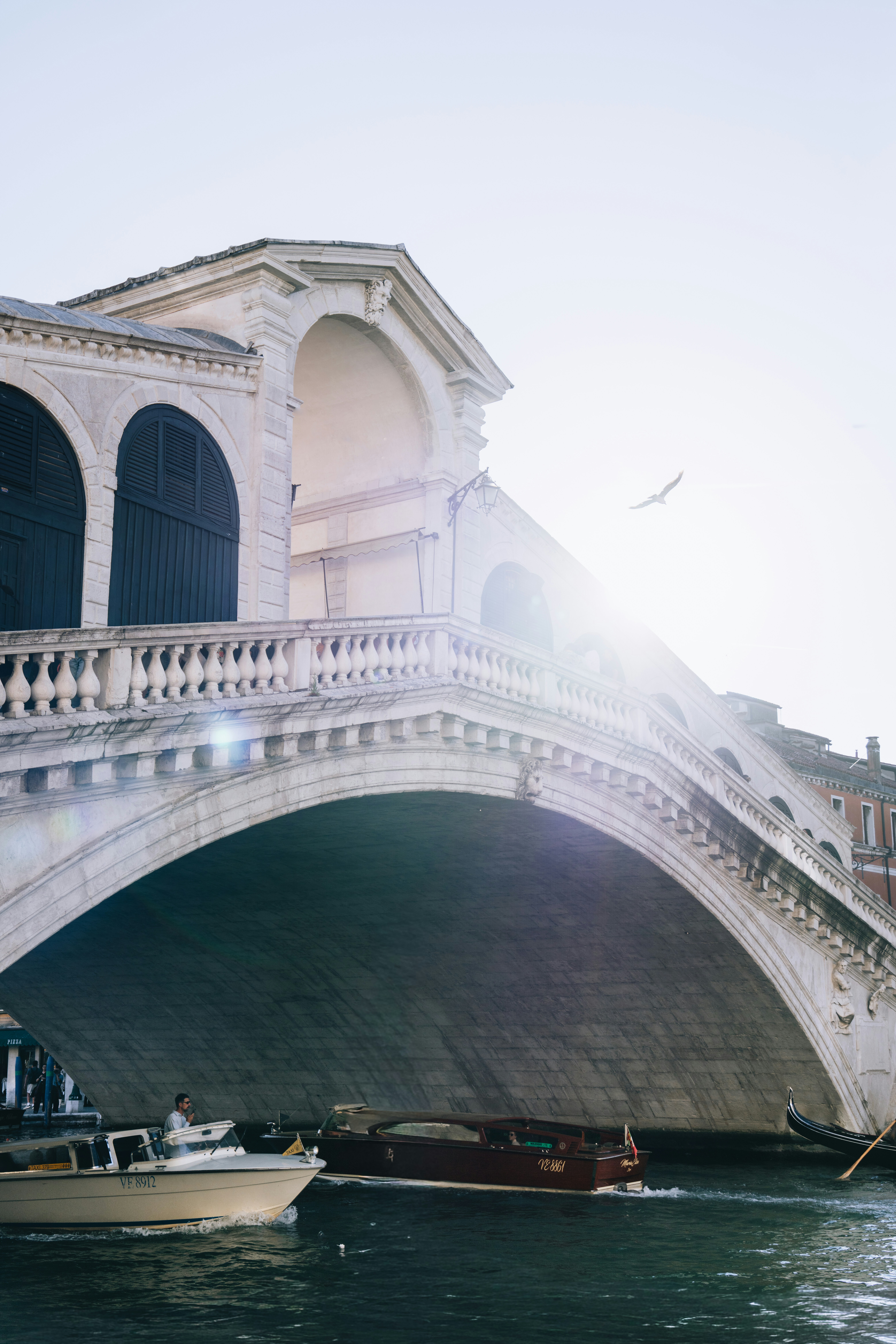 Sunlit Arc: Boats, Bridge, and the Quiet Vue of Venice