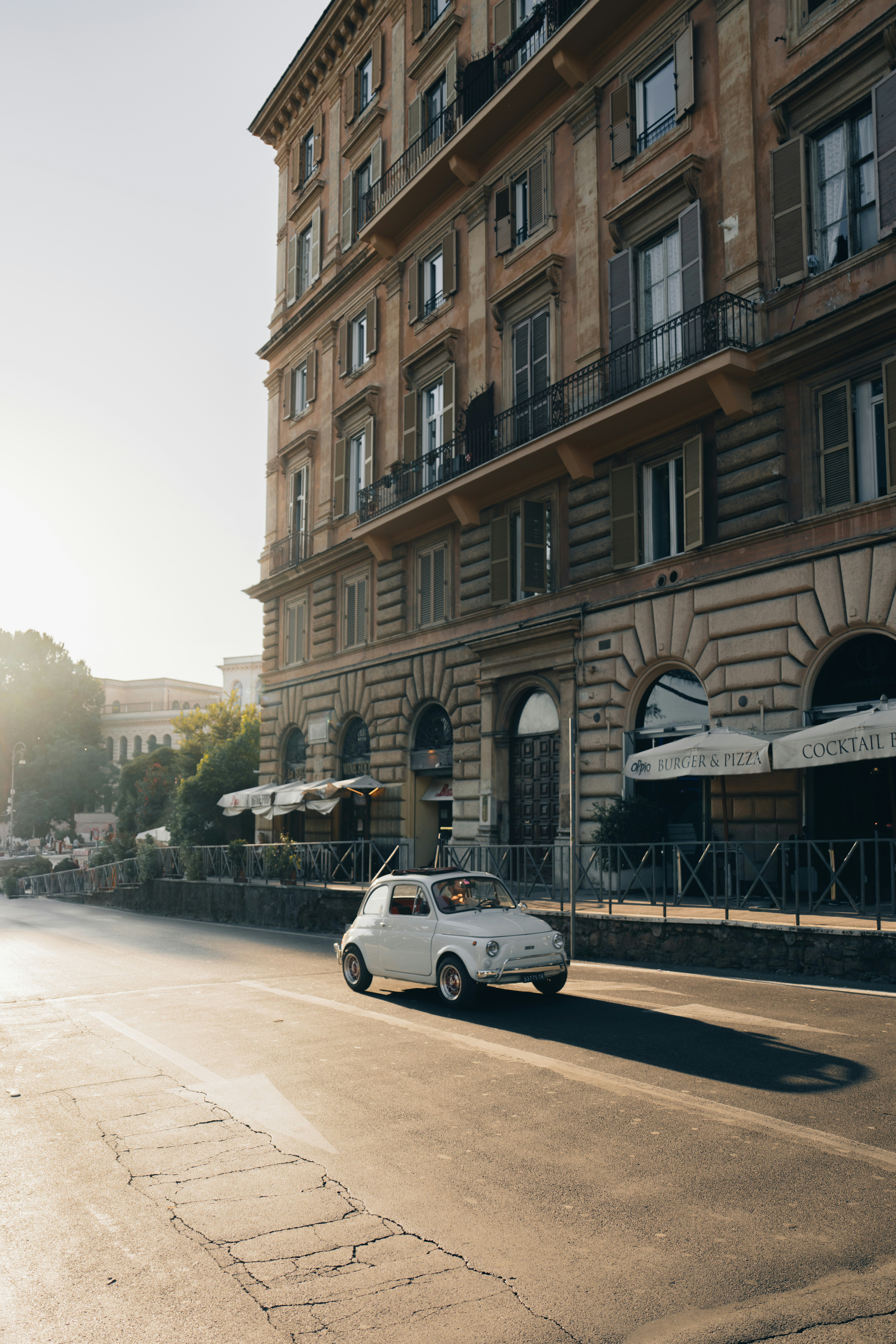 White Compact Car Beneath European Facade