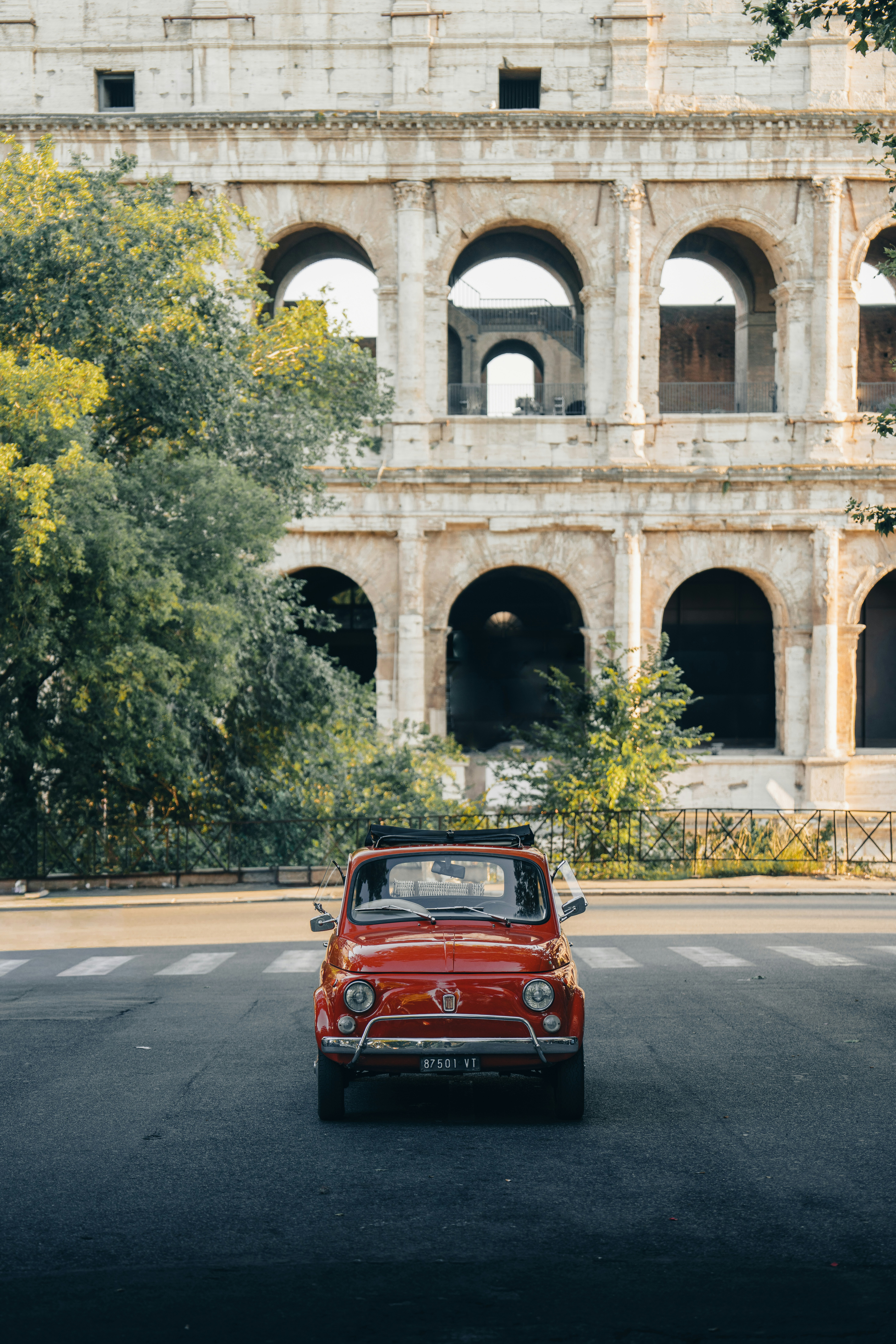 Red Vintage Convertible Before the Ancient Arches