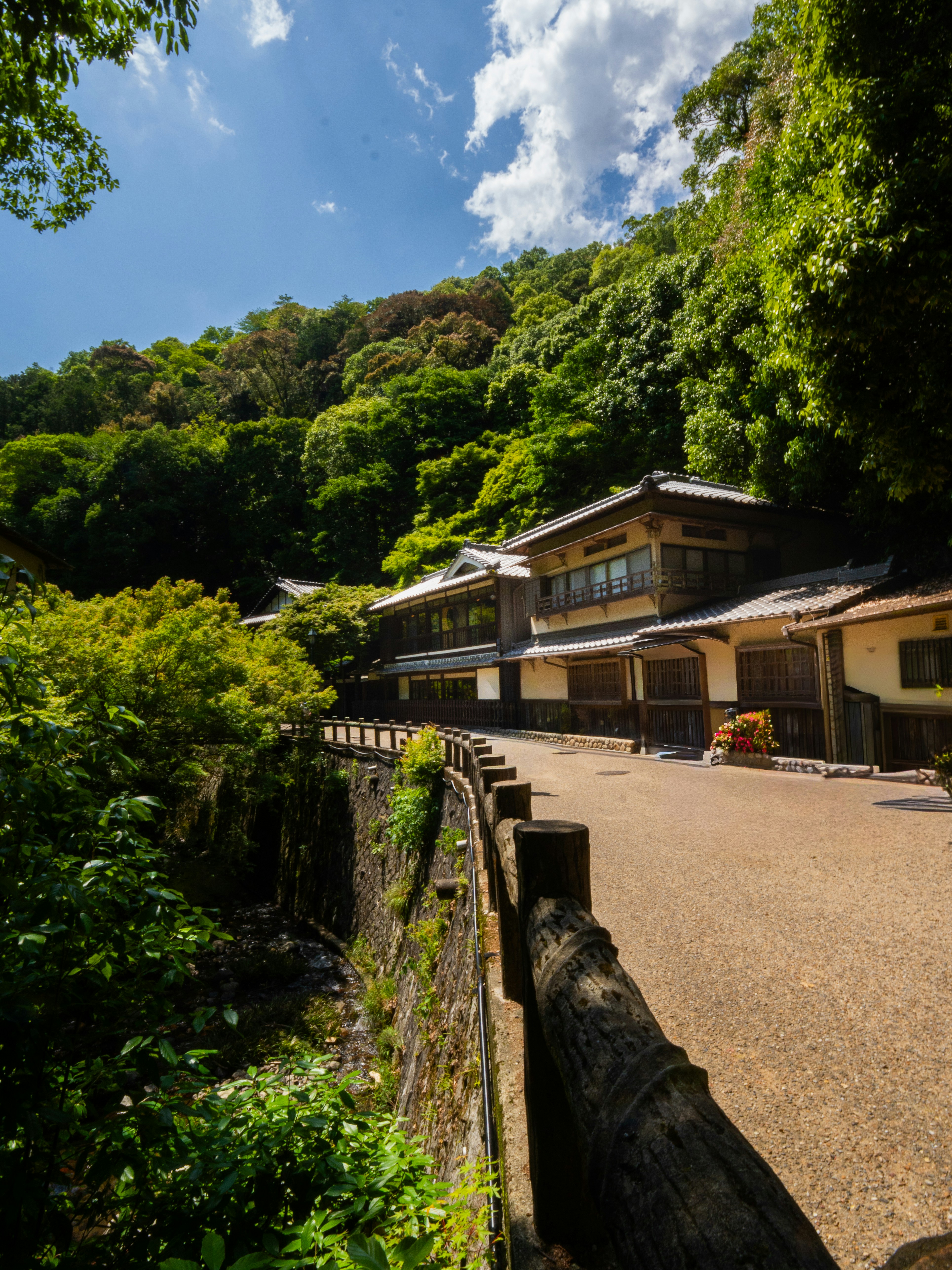 Traditional japanese buildings nestled among lush green mountains.