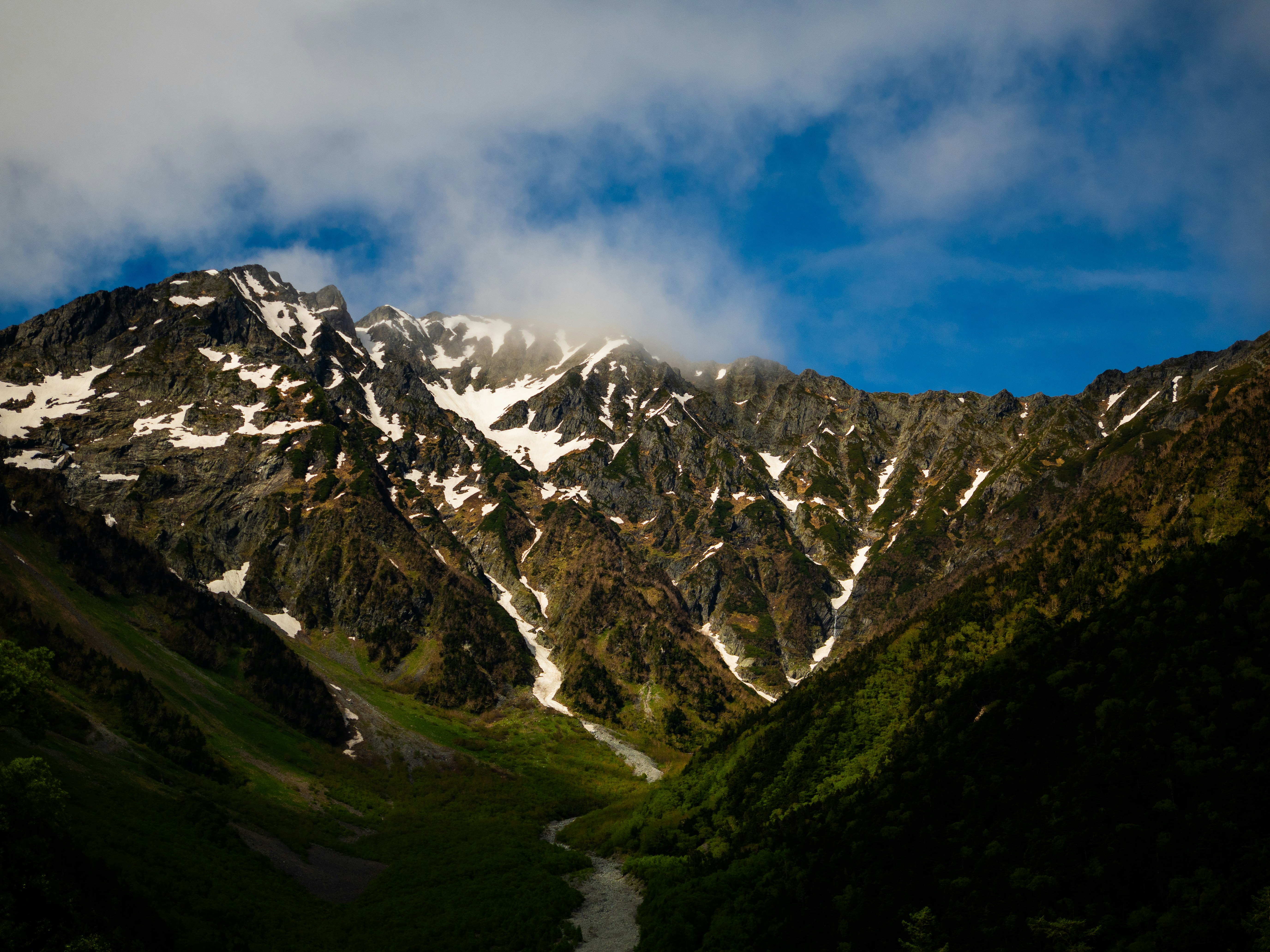 Snow-veined peaks under a cobalt sky