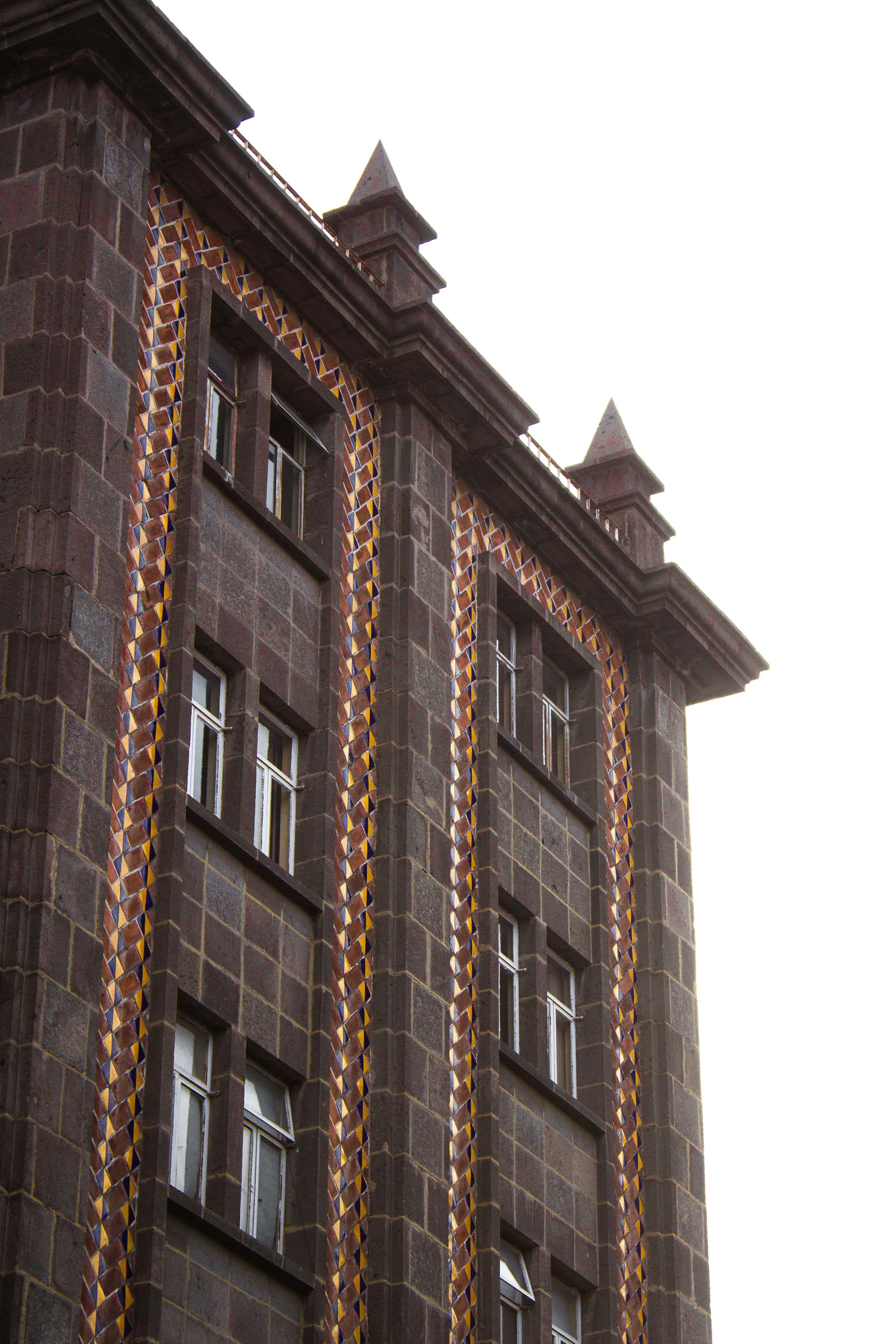 Gilded Masonry Frames: A Towering Facade with Geometric Ornament