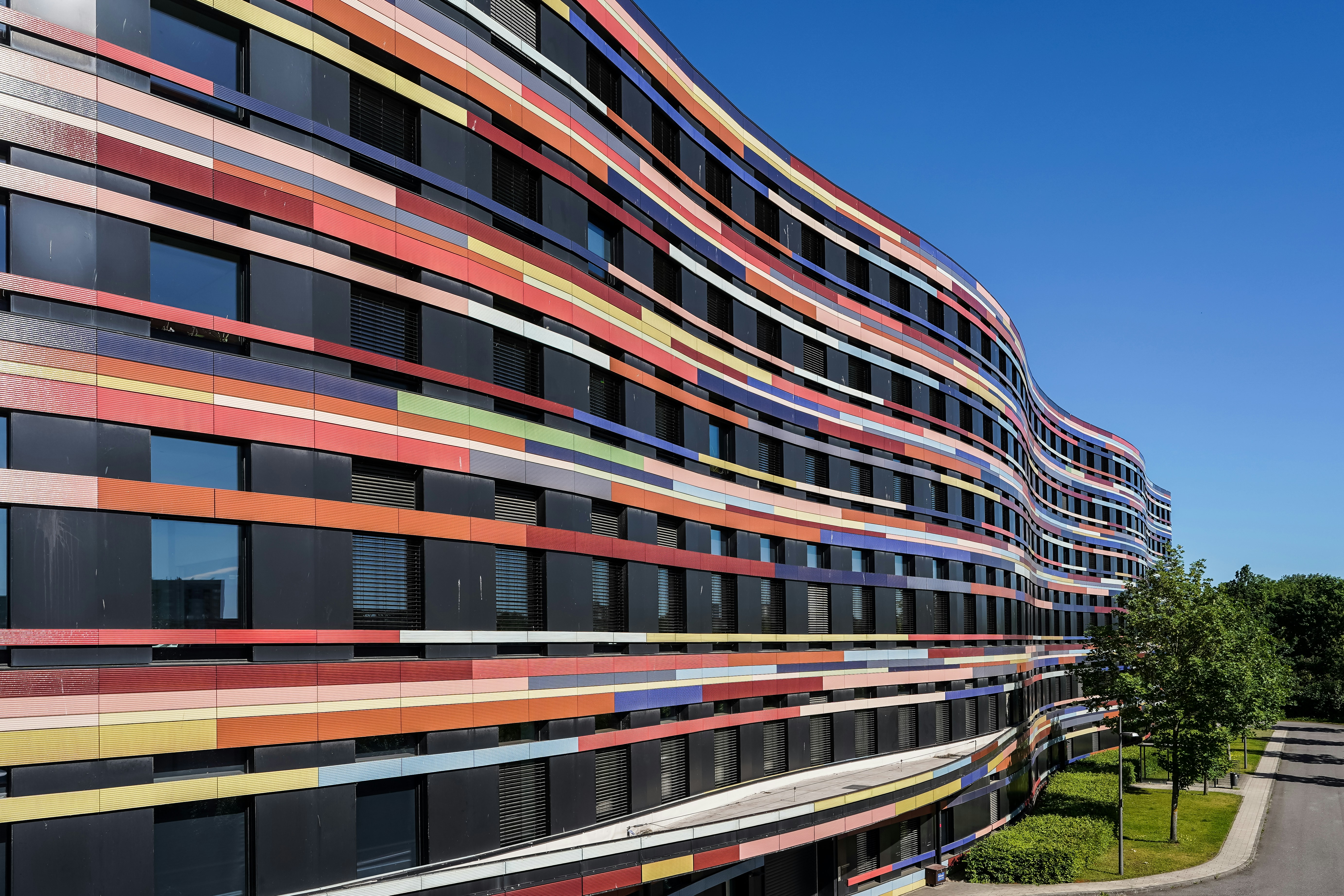 Curving Rainbow Facade: A Modern Wave of Color