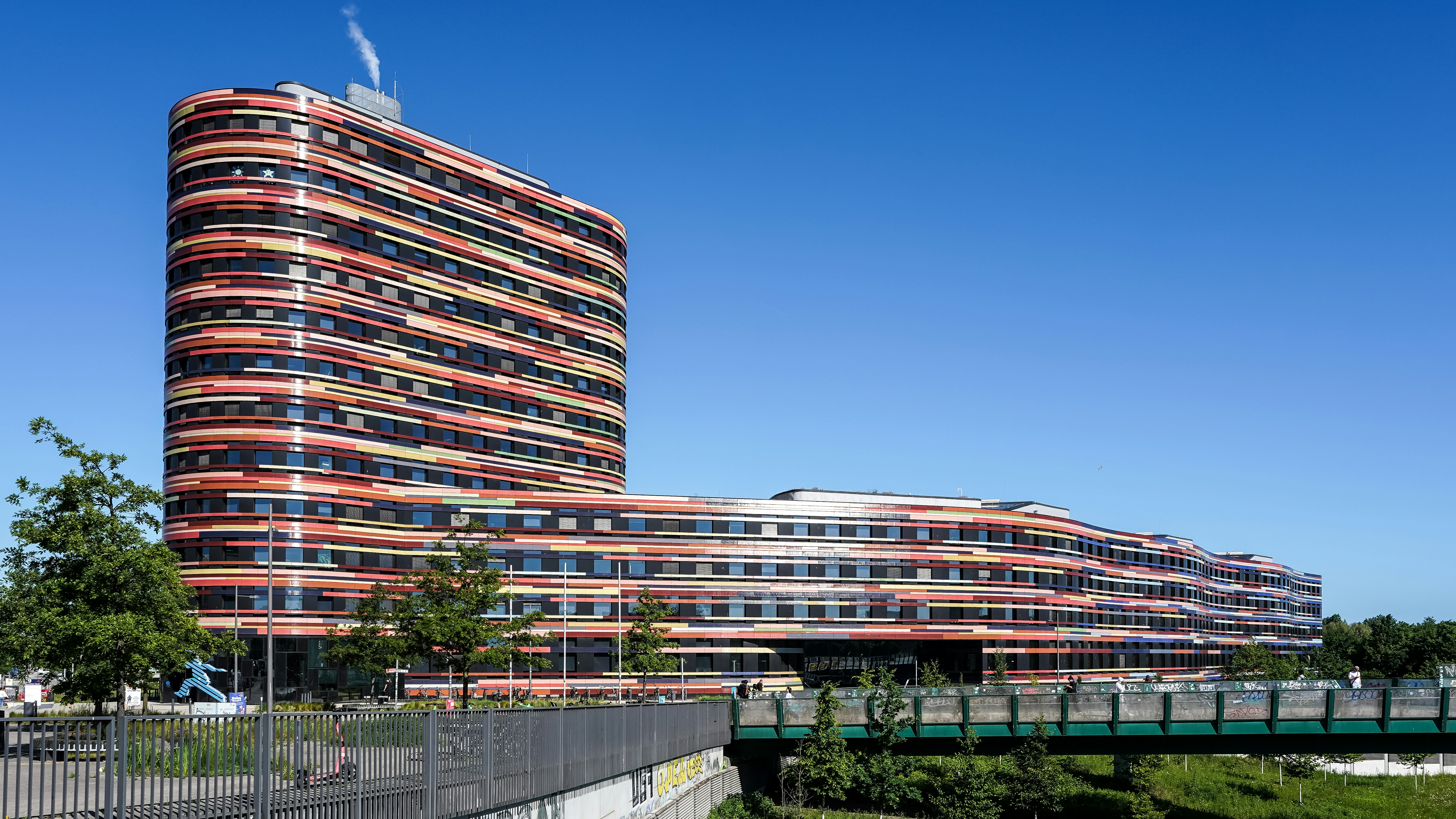 Curved Office Tower Crowned by a Clear Blue Sky