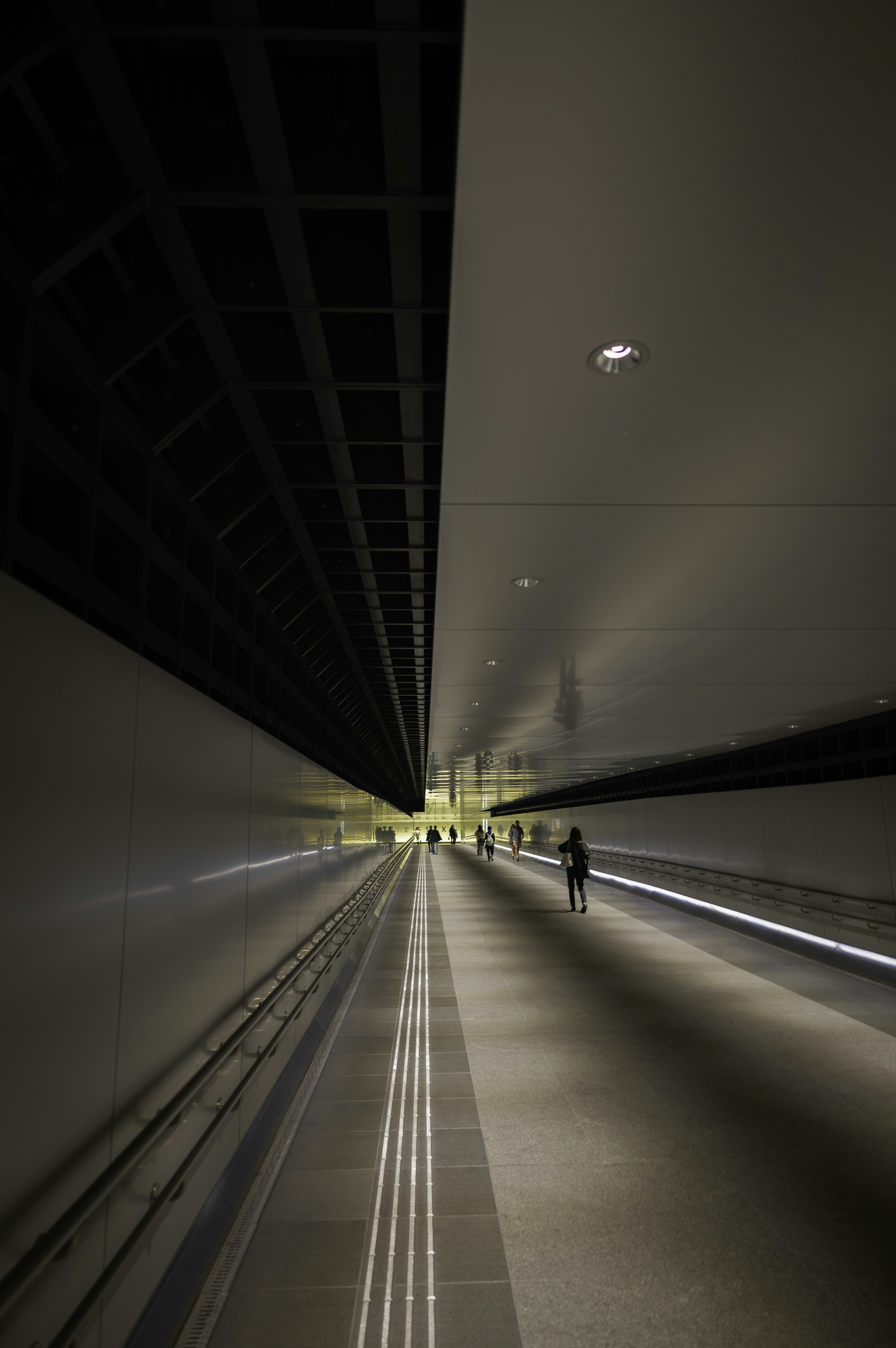 Vanishing Walkway: Echoes of Light in a Quiet Transit Corridor