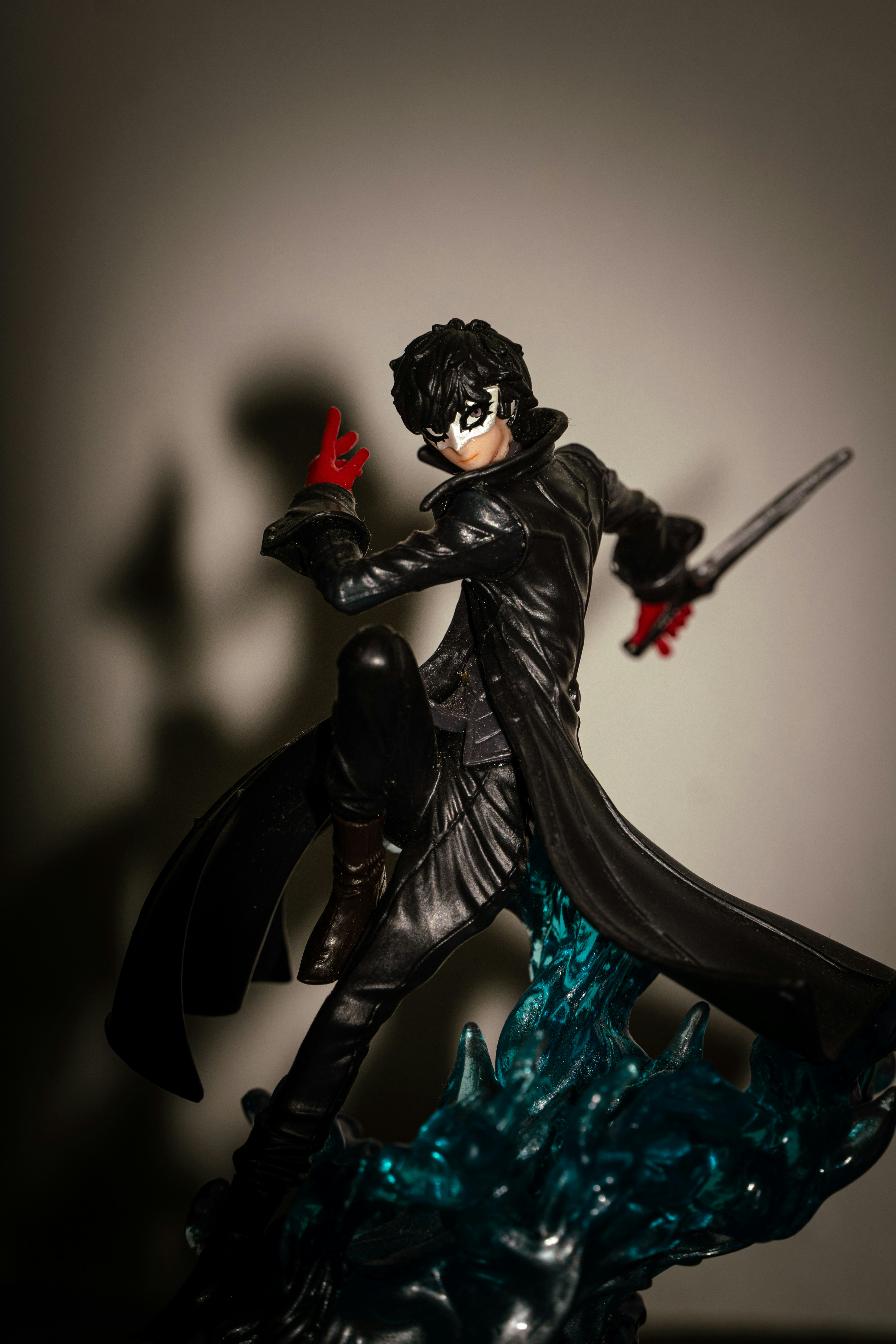 Persona 5 joker figurine in action pose with blue base.