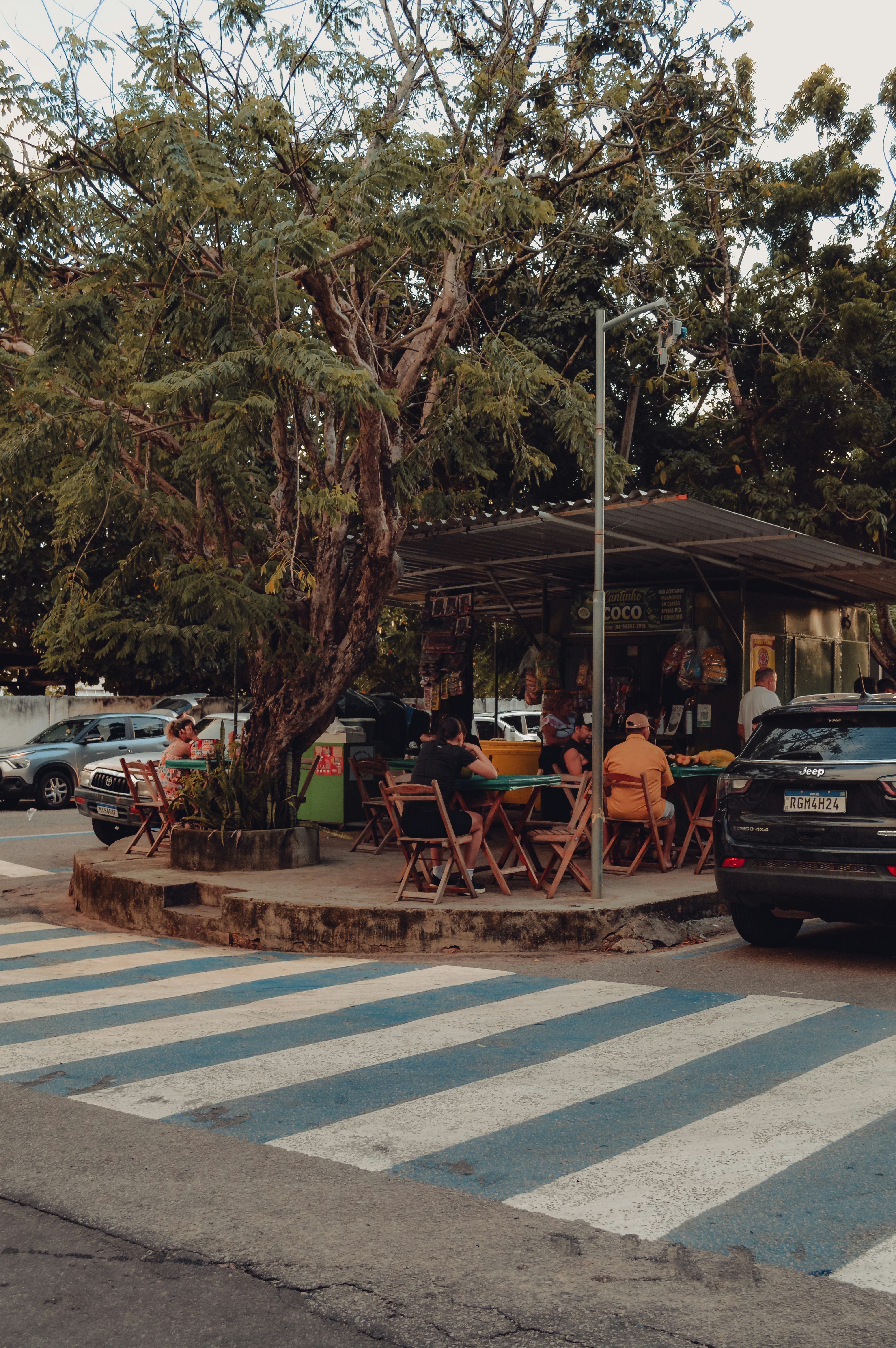Café Corner Under a Canopy: Evening Table Talk by the Street