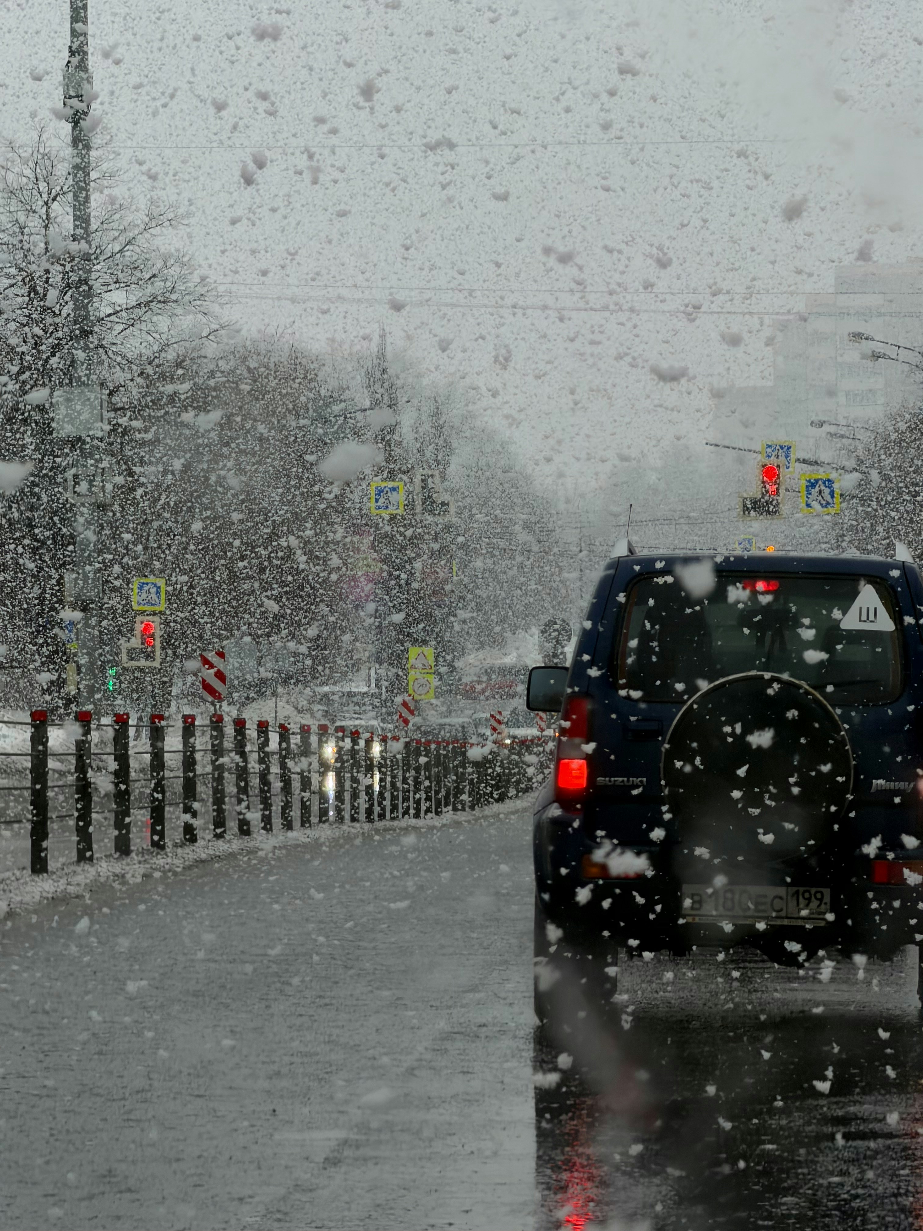 Snowstorm on the Boulevard: A Blue SUV in Winter Traffic