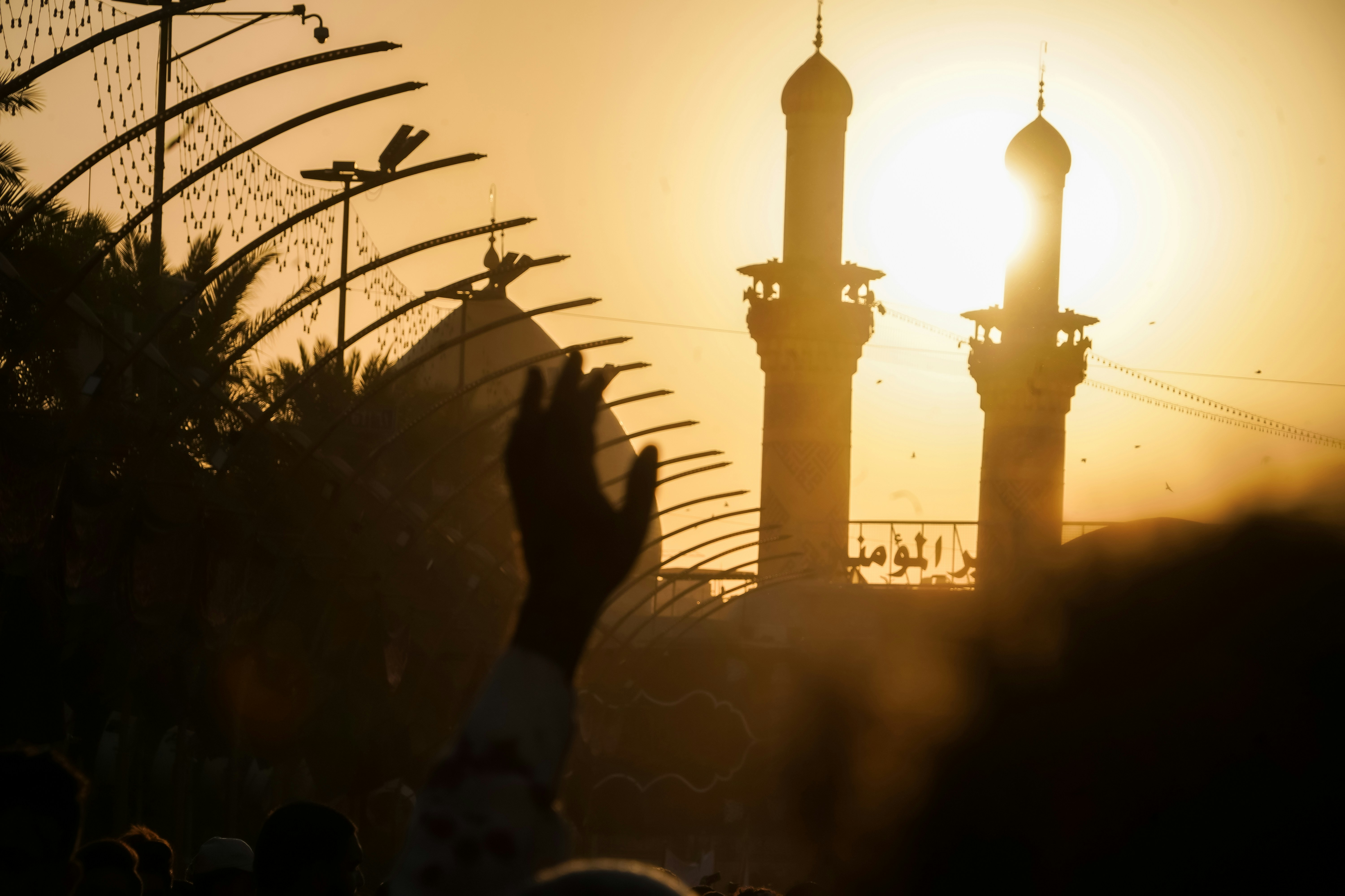 Rising Dawn Over Minarets: Hand Reaches Toward the Light