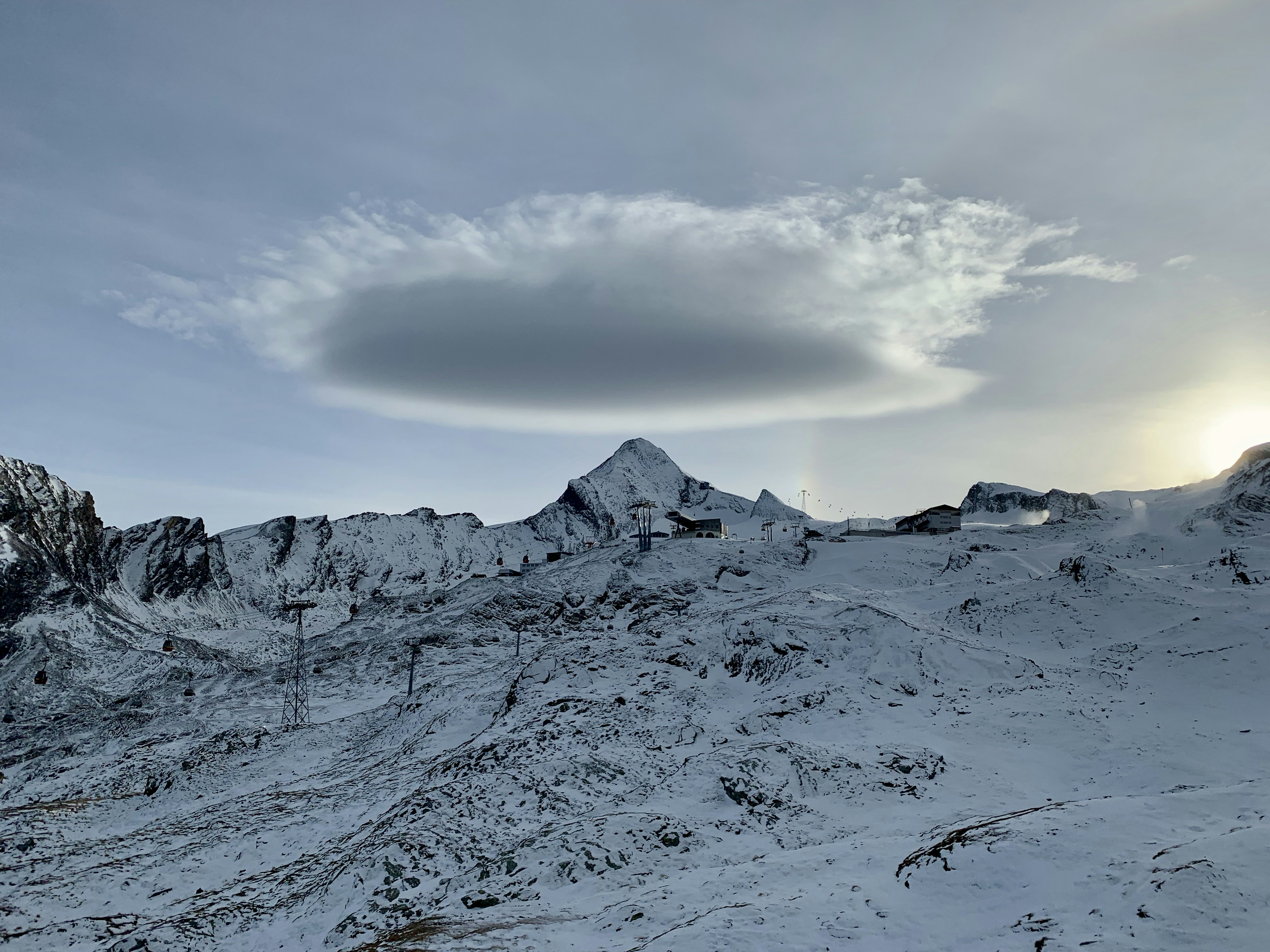 Halo Above the Ice Ridge: A Snow-Capped Summit at Dusk
