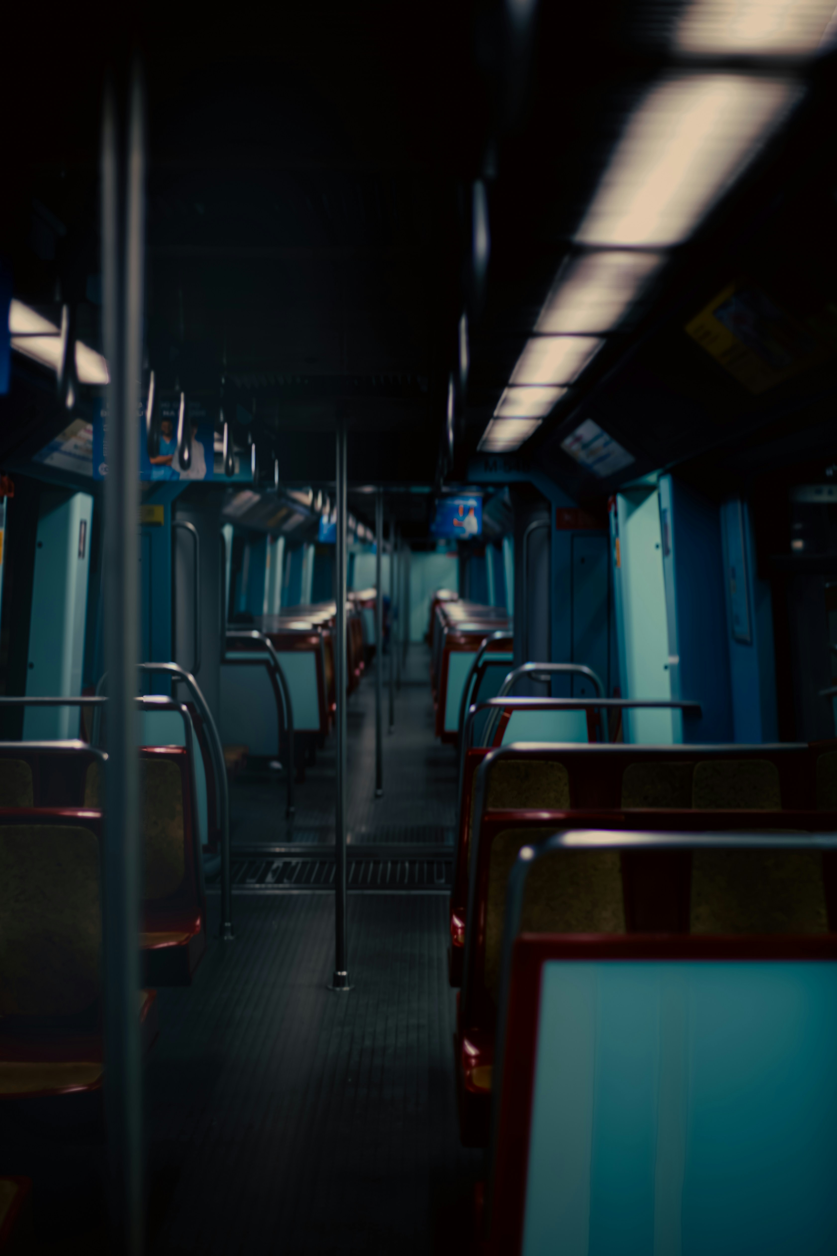 Midnight Carriage: A Quiet Train Interior Plunged in Neon Blues