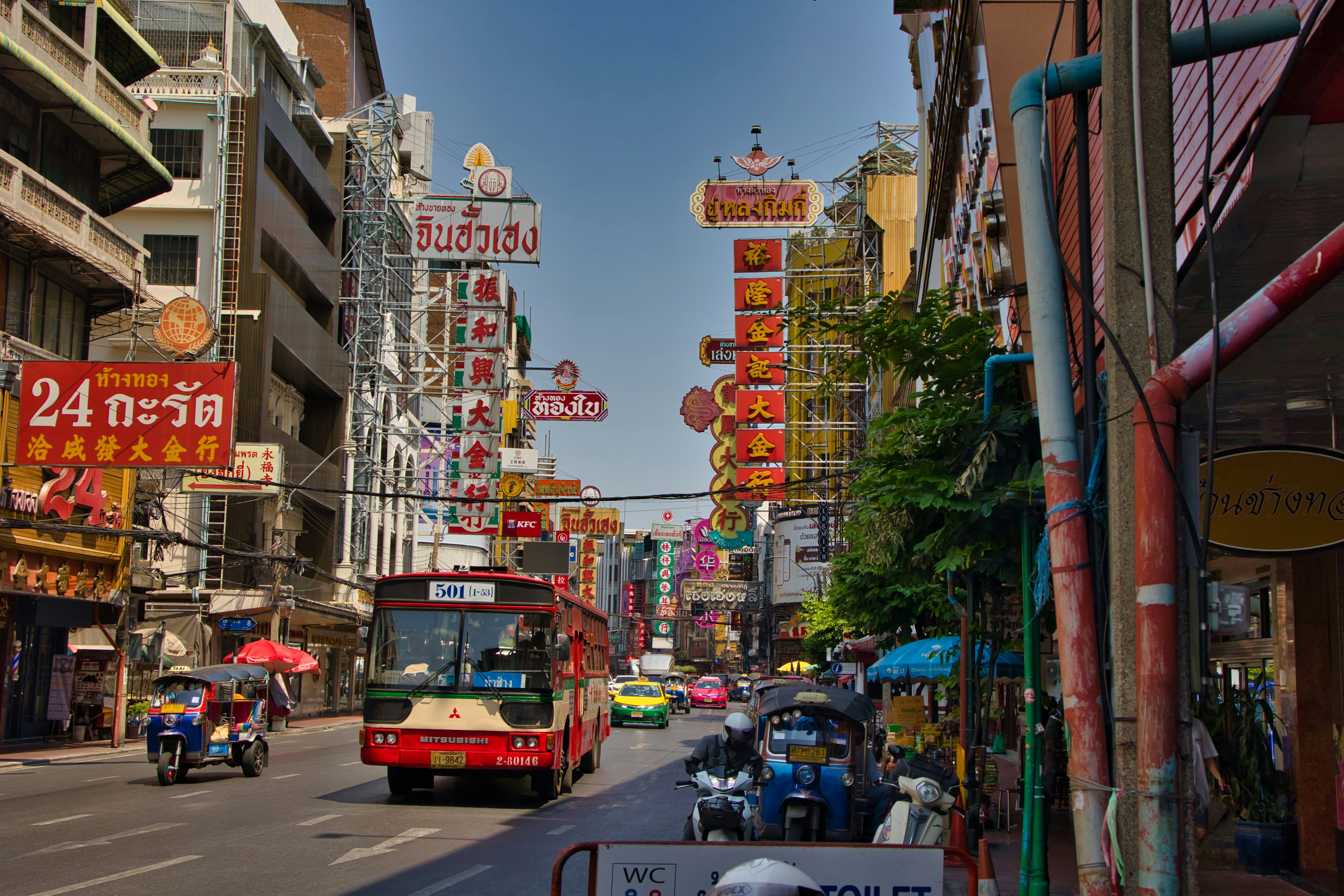 Bustling Bangkok Street Crossroads under Neon Canopy