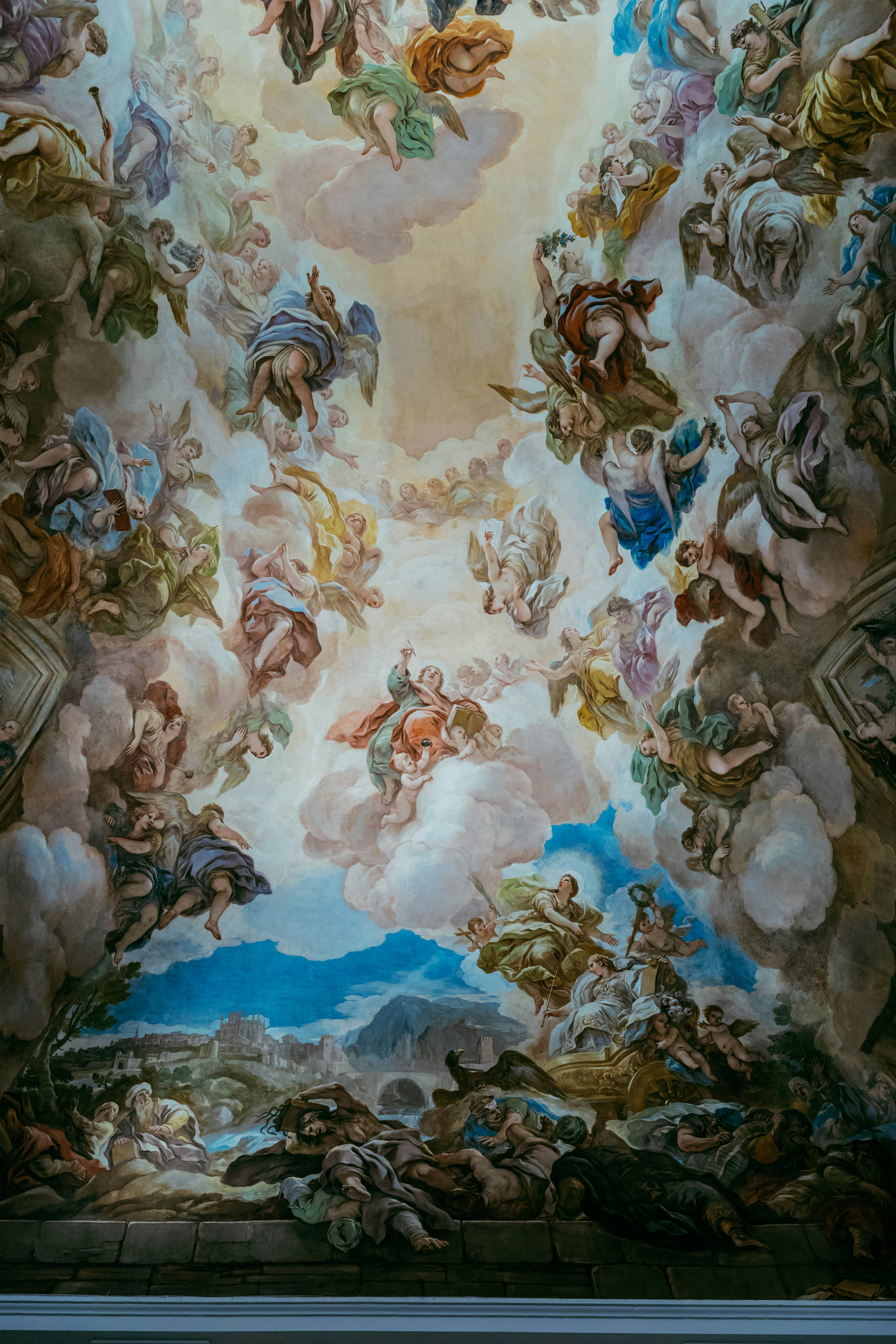 A detailed baroque ceiling fresco depicting angels and figures.
