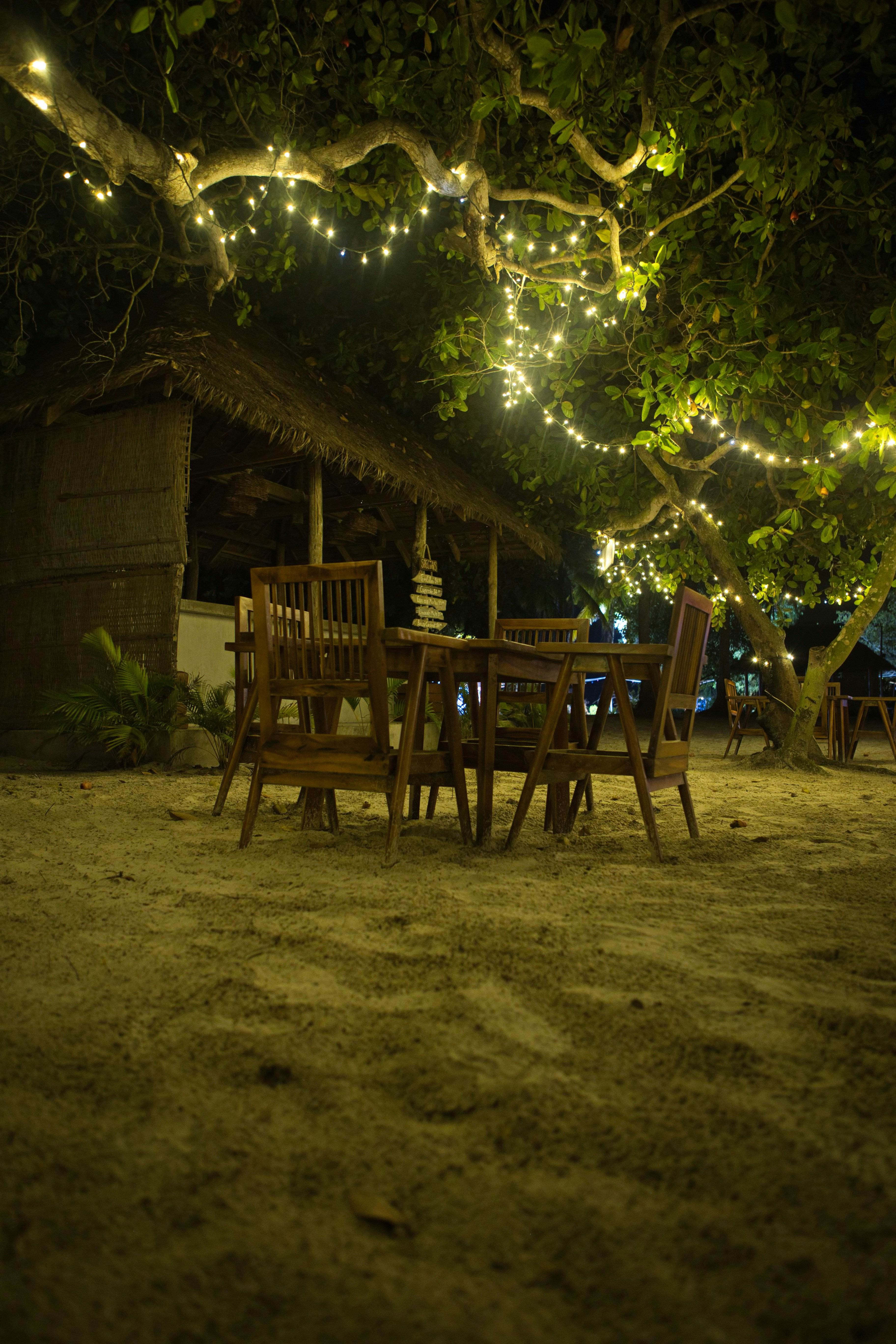 Moonlit Beach Bistro: String Lights, Wooden Tables, and a Quiet Night