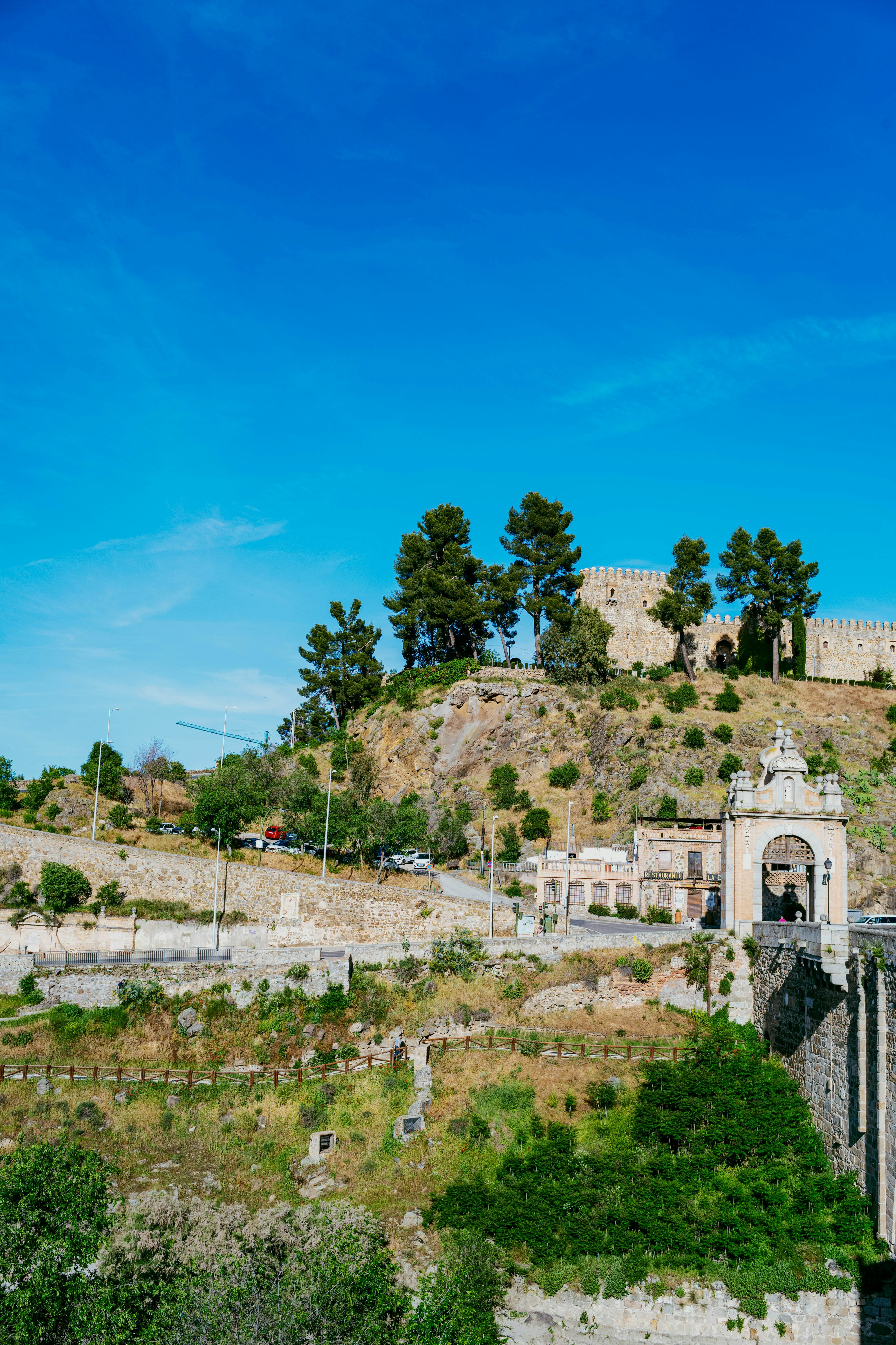Hilltop Fortress and Arcaded Gateway Under a Brilliant Blue Sky